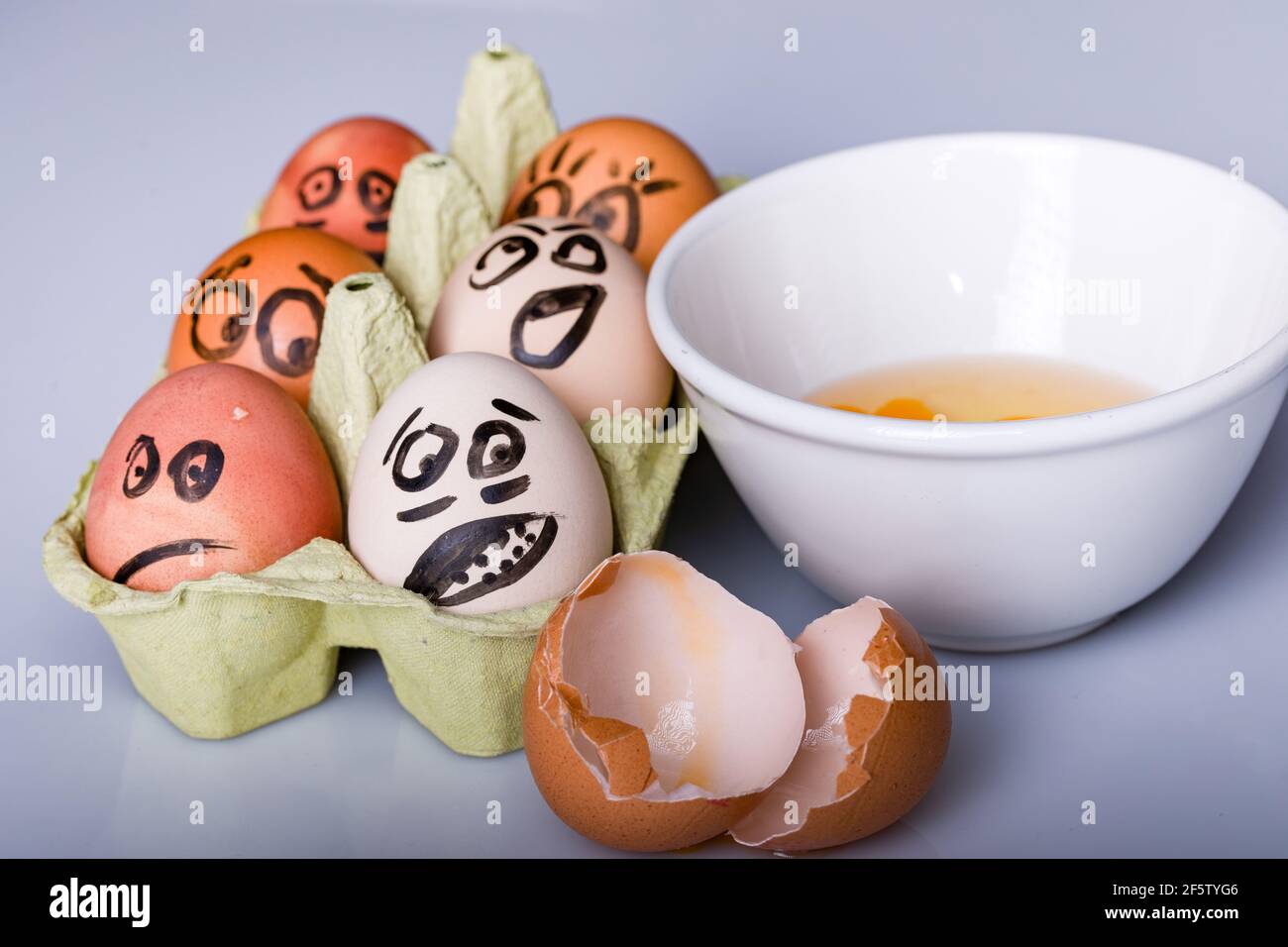 Crazy eggs terrified, Scared faces staring from egg tray at broken egg. Funny easter stories ...