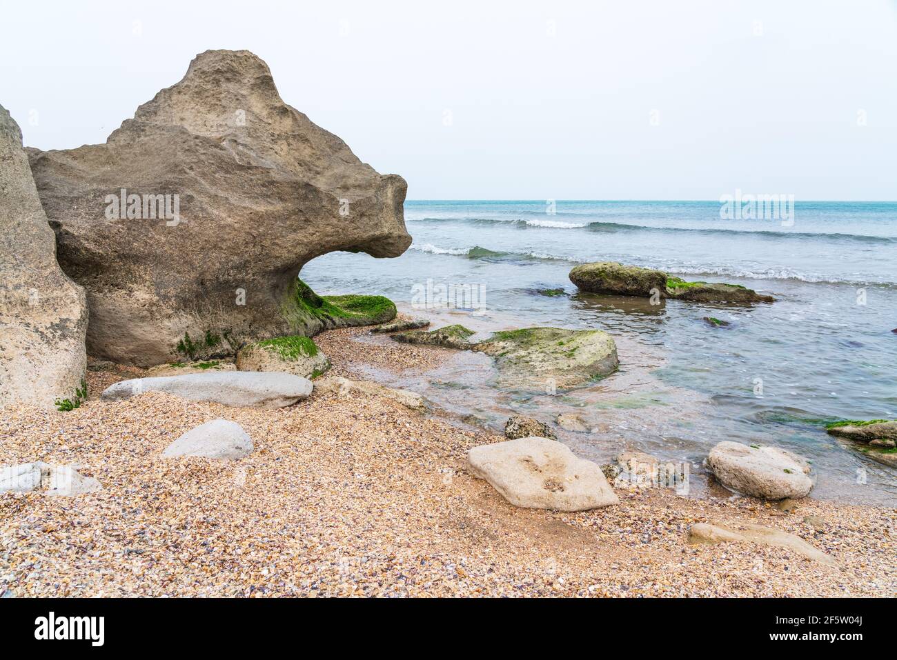 Rocky sea beach with boulders Stock Photo - Alamy