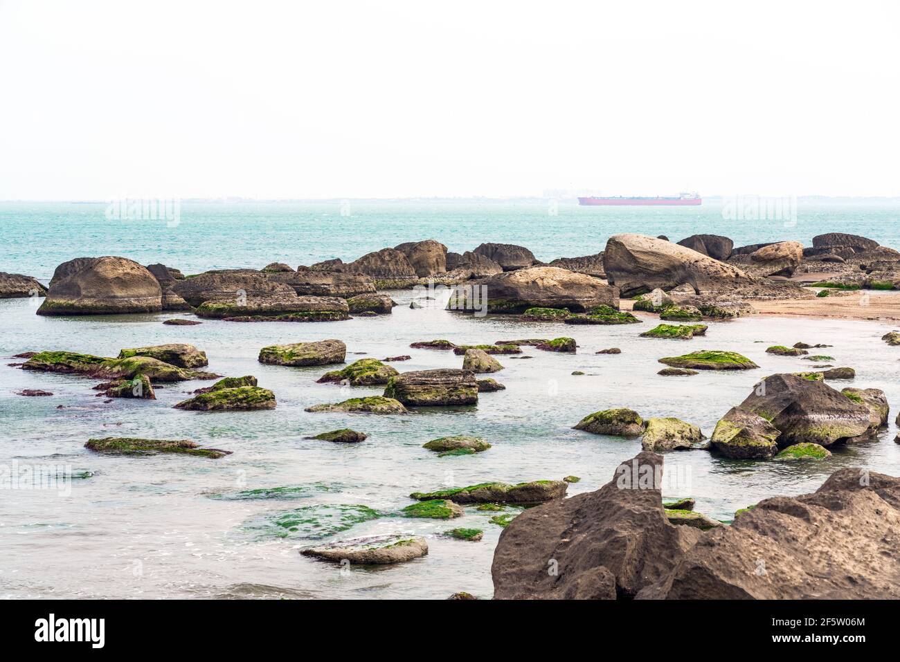 Rocky sea beach with boulders Stock Photo - Alamy