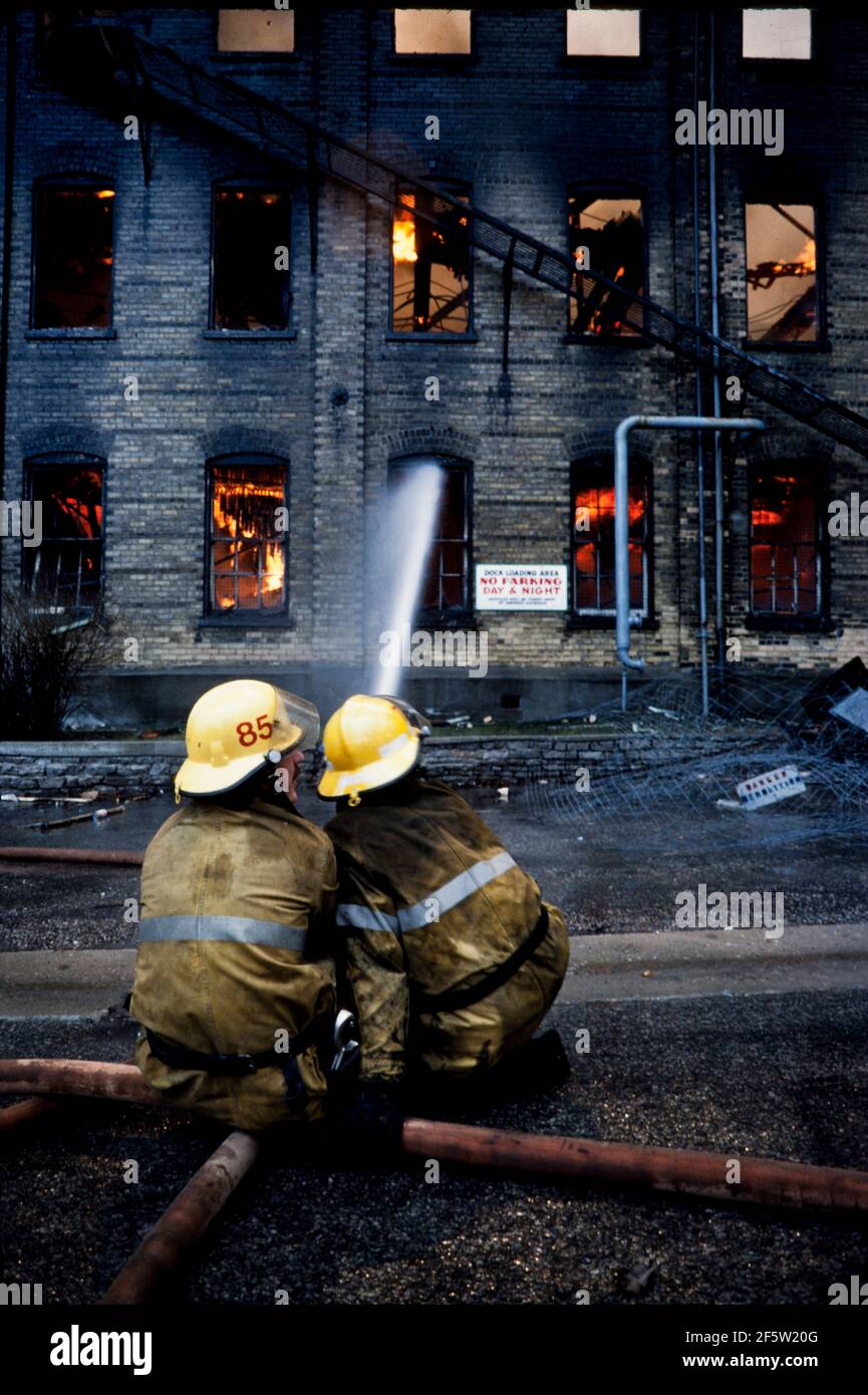 Fire, firemen extinguishing a blazing building Stock Photo - Alamy