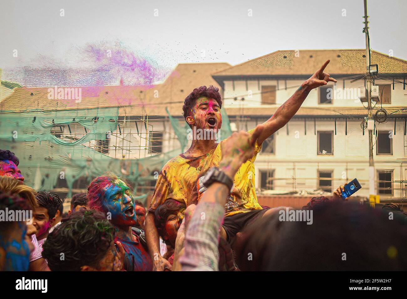 Revellers dance as they celebrate Holi festival. Holi is a popular ...