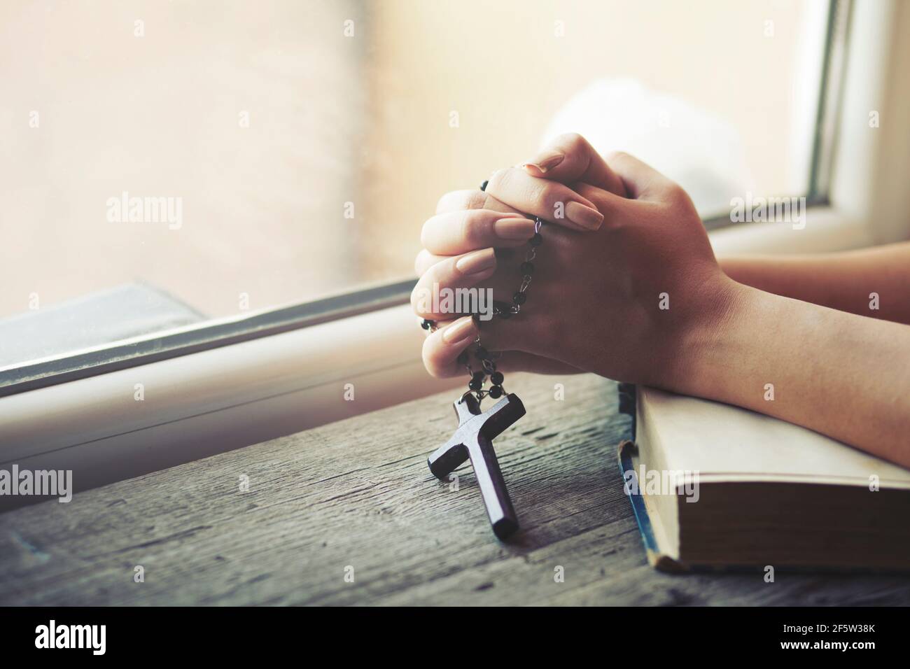 Woman hand wooden cross hi-res stock photography and images - Alamy