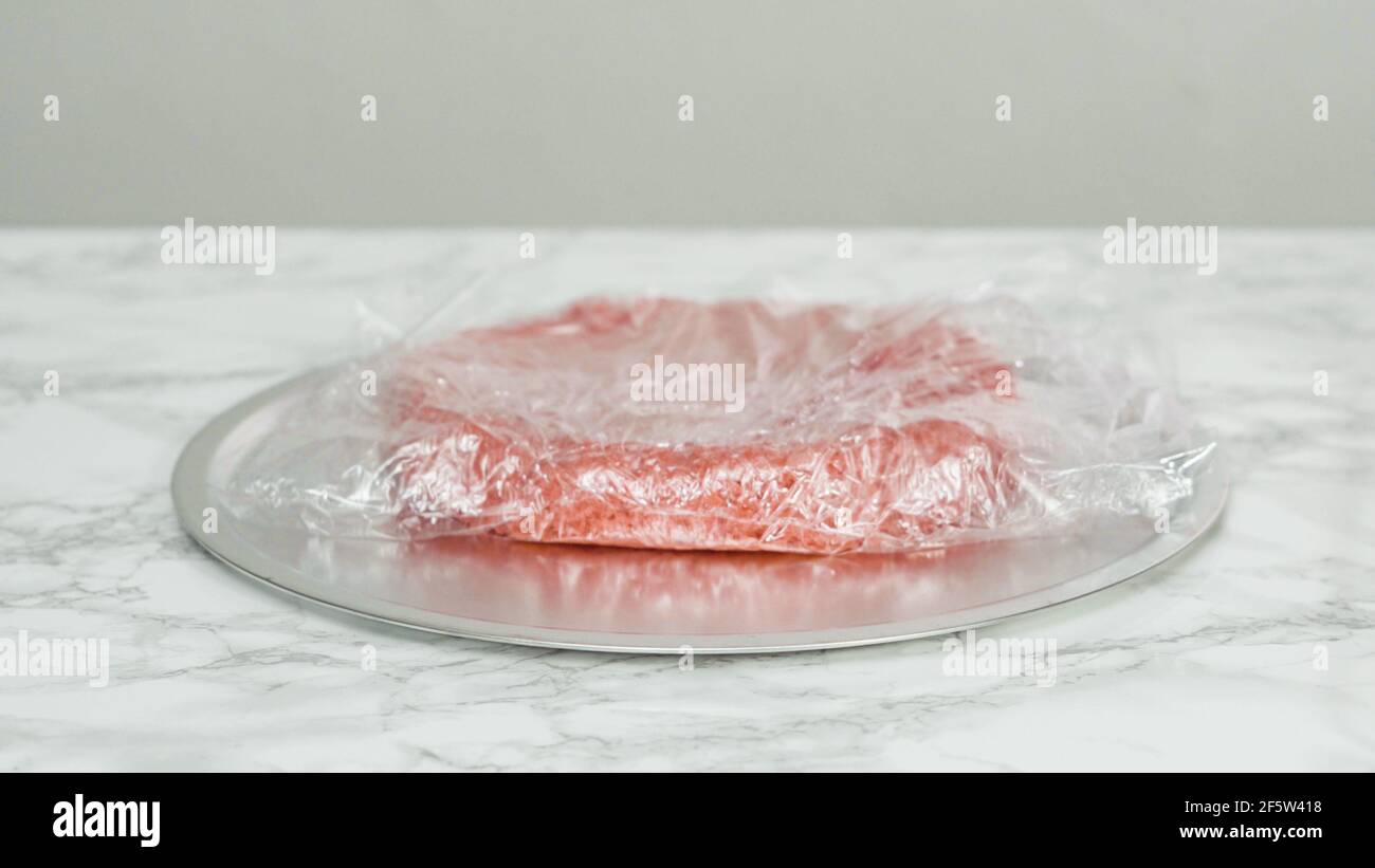 Step by step. Wrapping freshly baked cake layers into clear food wrap ...