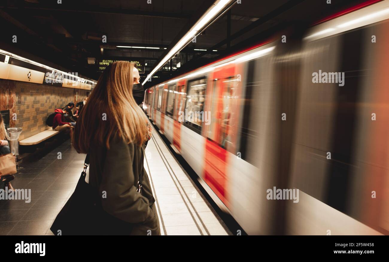 Woman waiting for the train hi-res stock photography and images - Alamy