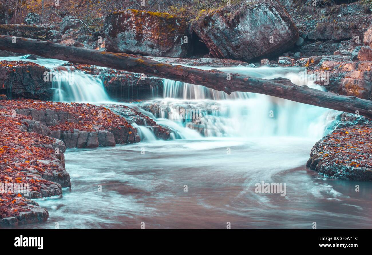 View of waterfall and sunny beams in deep forest at National Park Stock ...