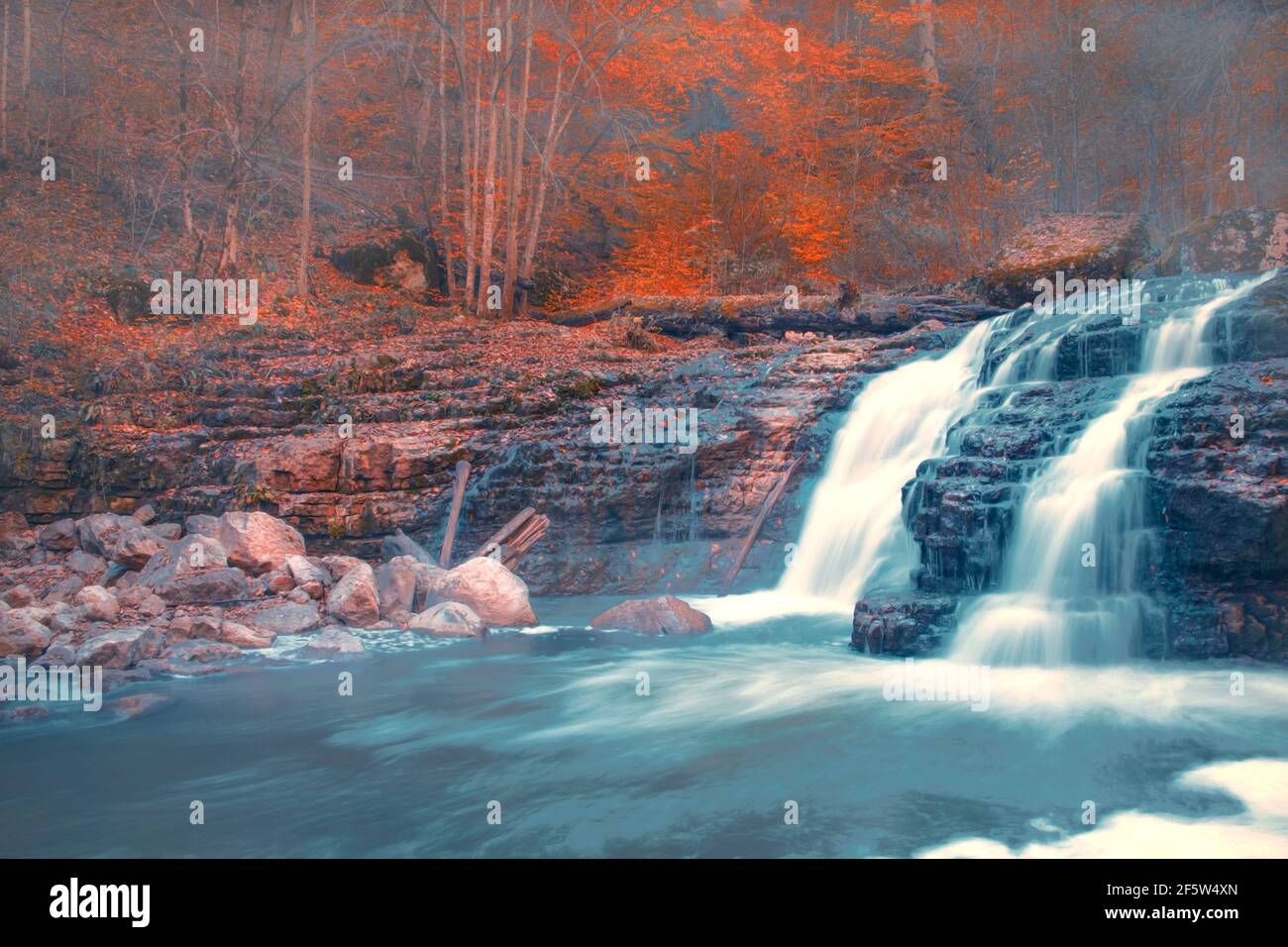 View of waterfall and sunny beams in deep forest at National Park Stock ...