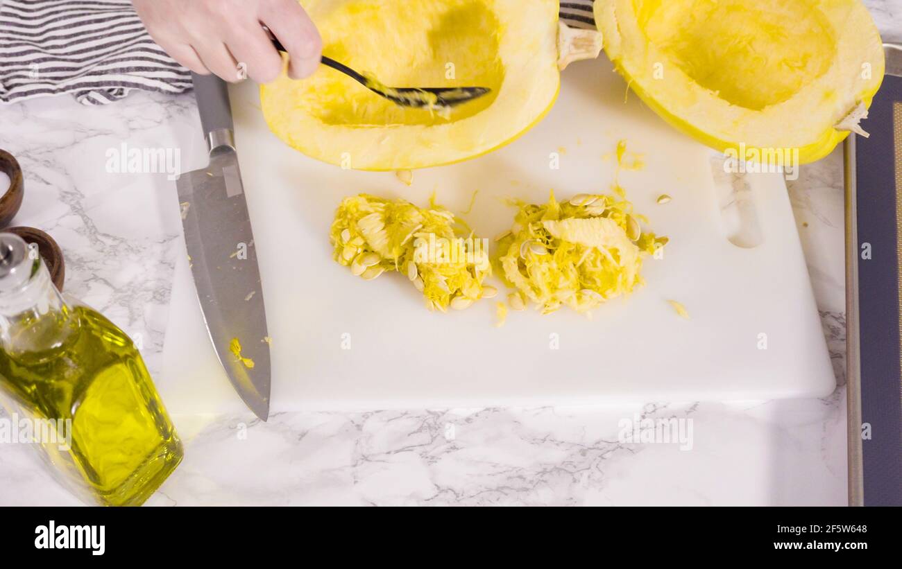Step by step. Preparing organic spaghetti squash with olive oil, salt ...