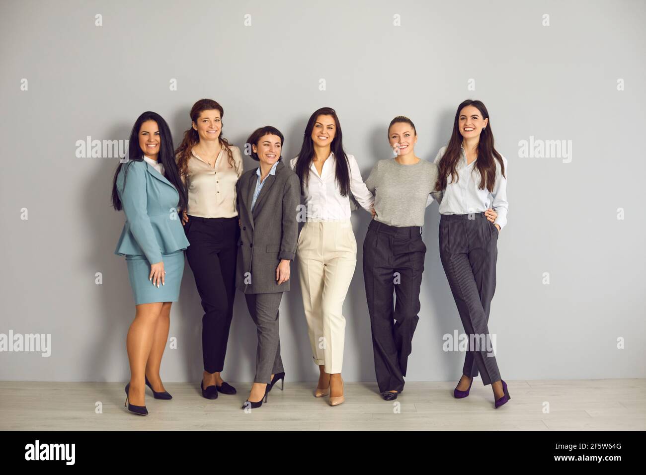Group portrait of successful and stylish business women posing against ...