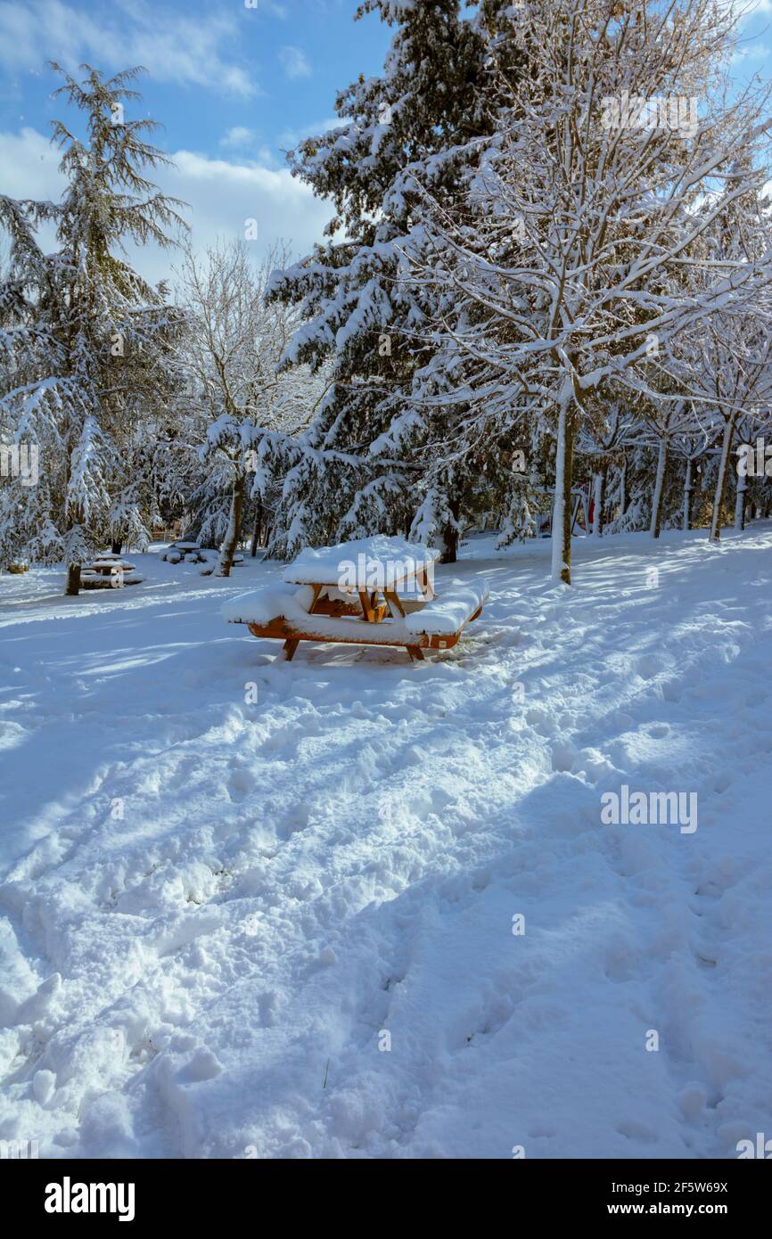 Snow covered picnic table in the park at winter. Snowy park. Winter ...