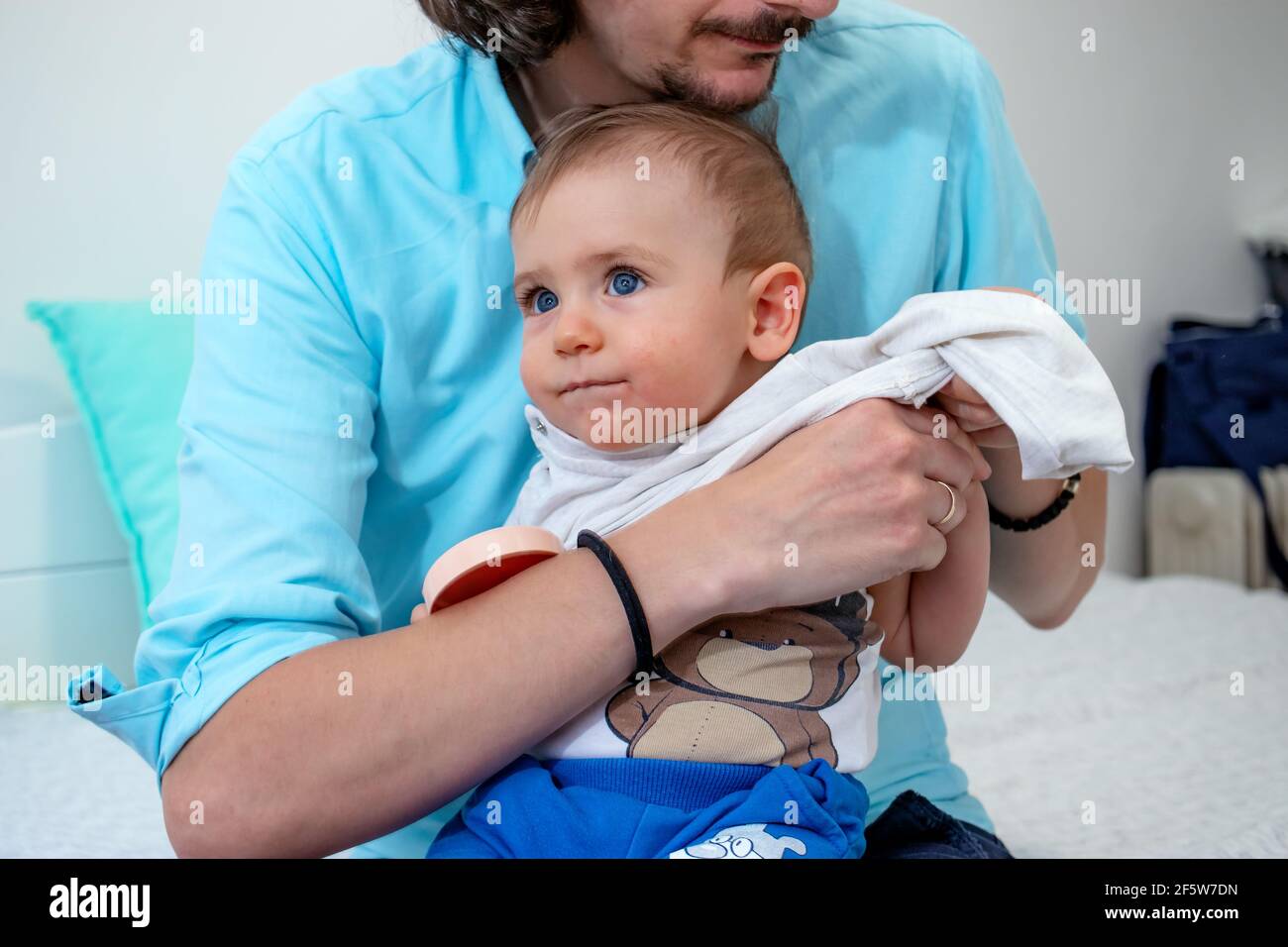 Dad baby dressing hi-res stock photography and images - Alamy