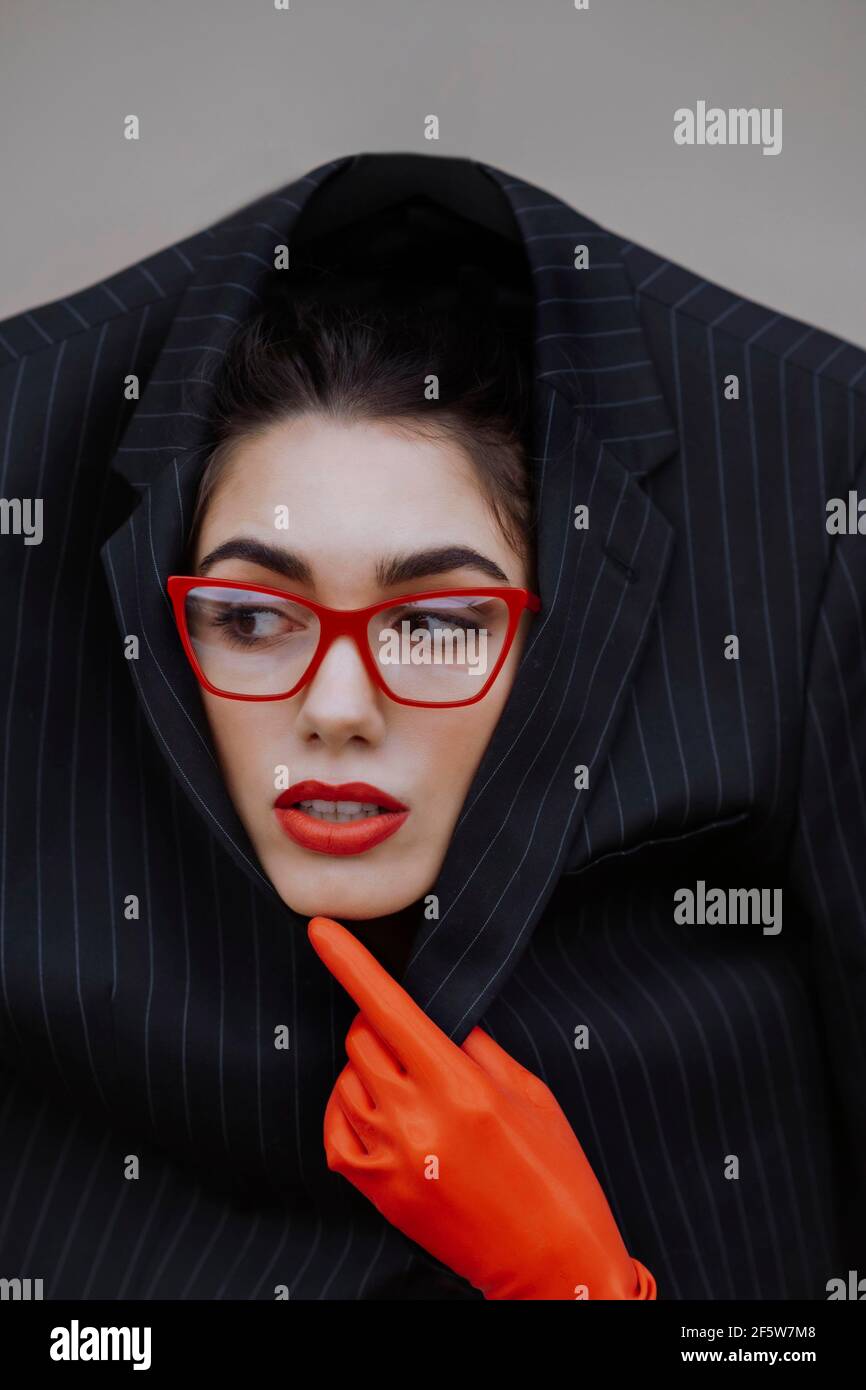 Made up woman with glasses in man jacket Stock Photo - Alamy