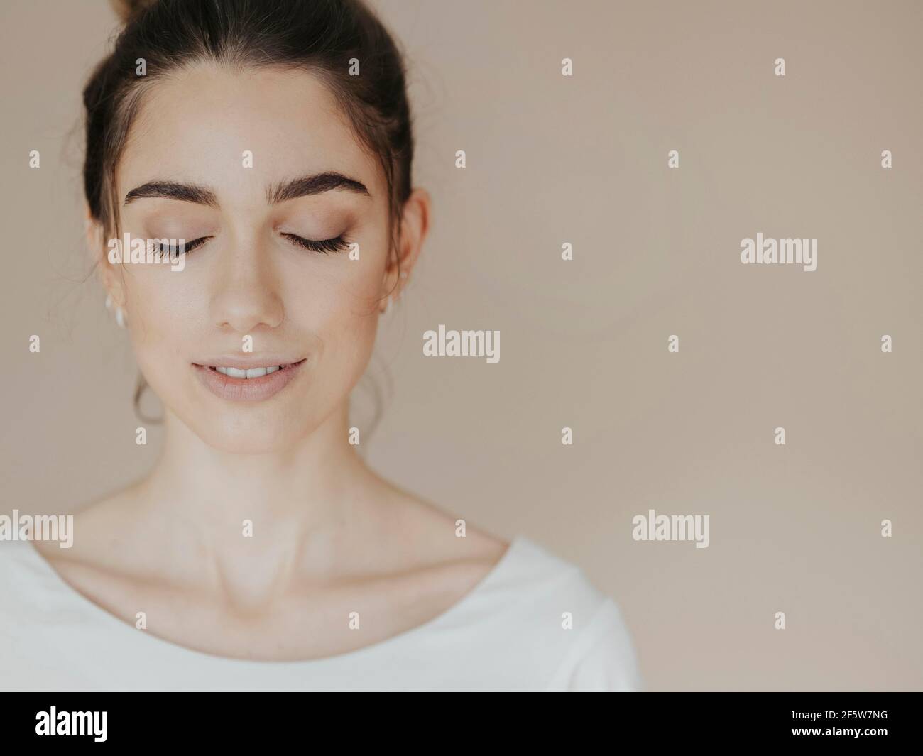 Young woman with closed eyes, smiling Stock Photo - Alamy