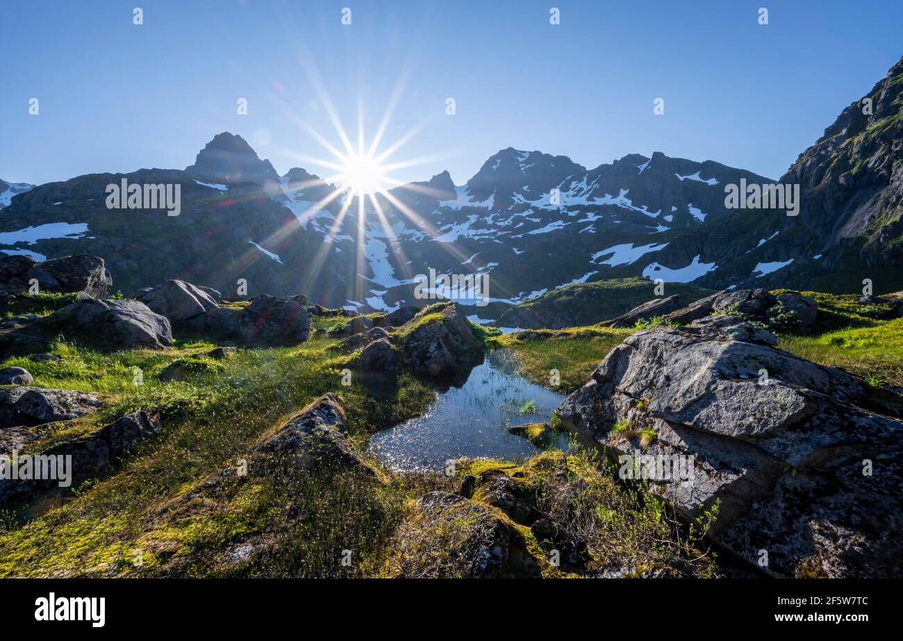 High moor, sun shining on mountains with snow, mountain range at ...