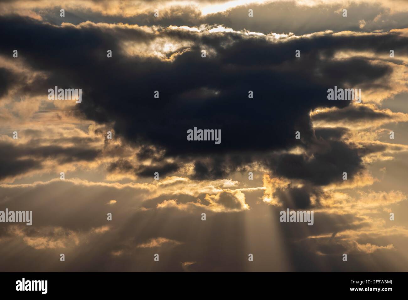 Sun behind dark clouds, evening sun, Germany Stock Photo - Alamy