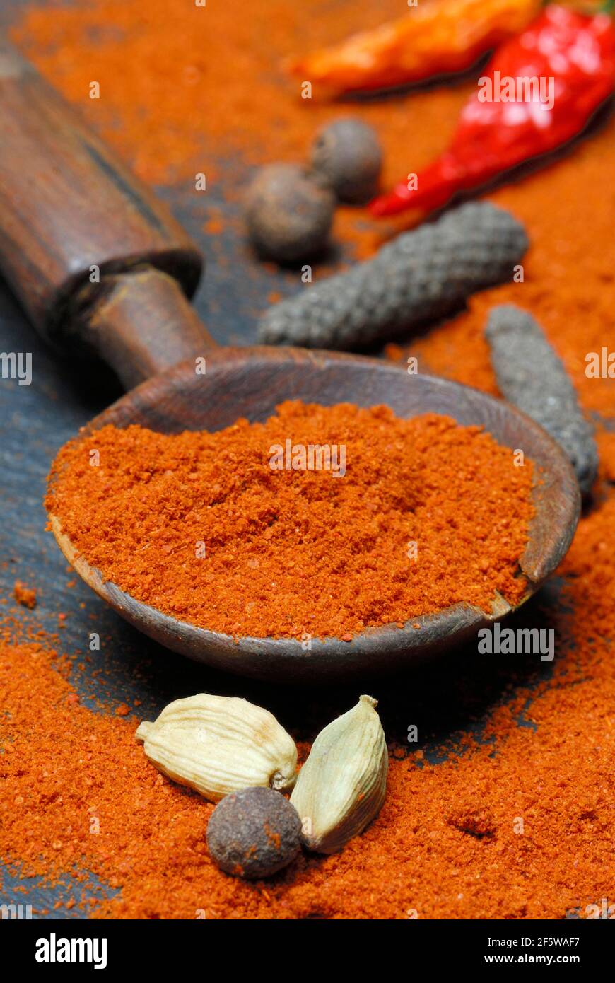 Powder in a wooden spoon (Berbere) , spice mixture of chili, pimento ...