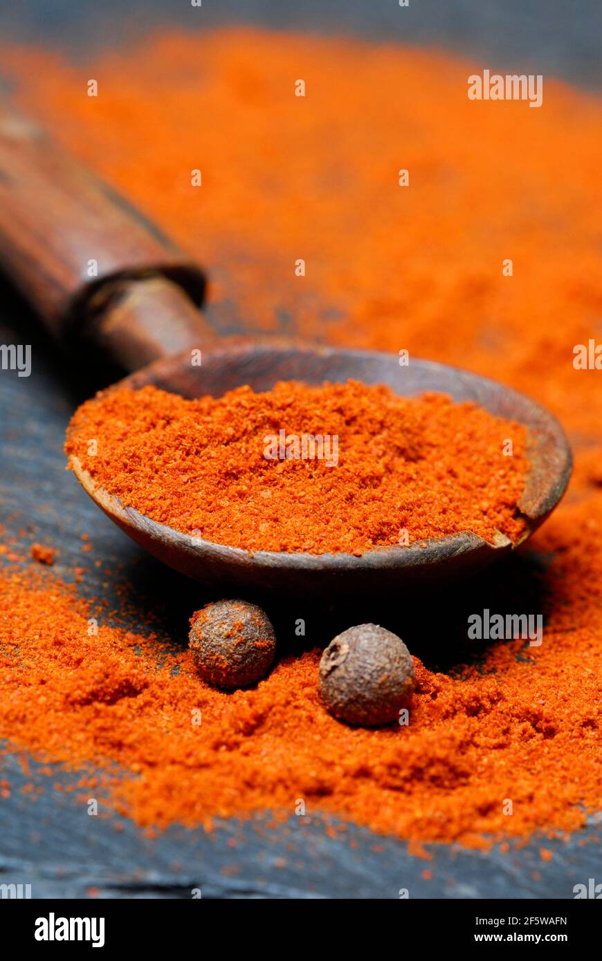 Powder in a wooden spoon (Berbere) , spice mixture of chili, pimento ...