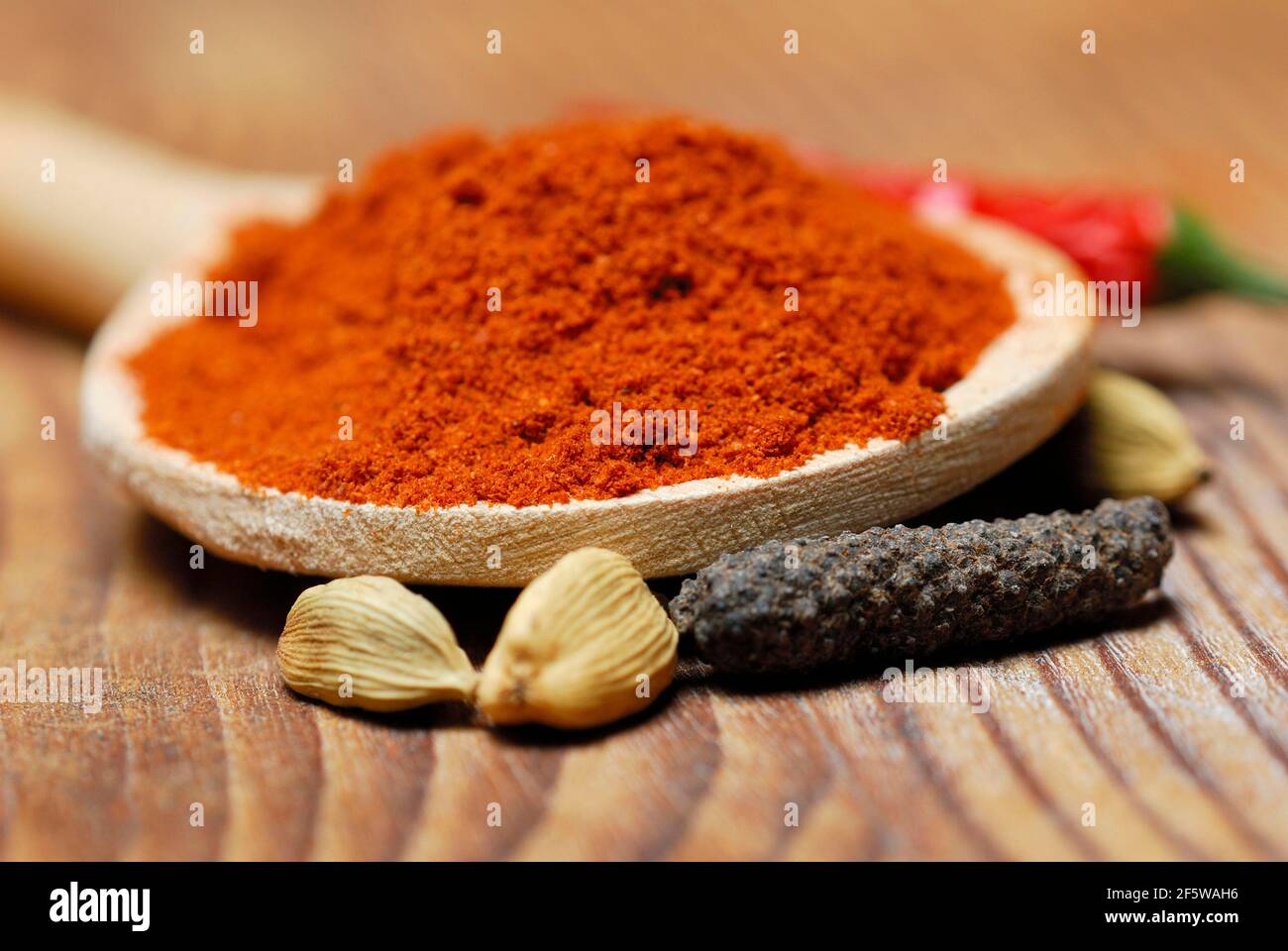 Powder in a wooden spoon (Berbere) , spice mixture of chili, pimento ...