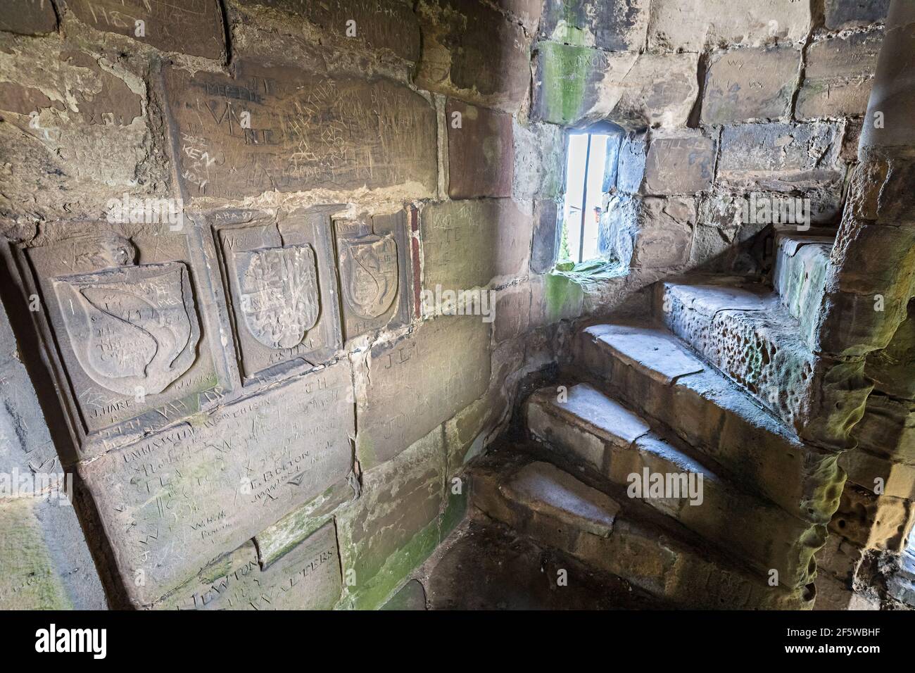 Family coat of arms and graffiti carved into the staircase wall, in the ...