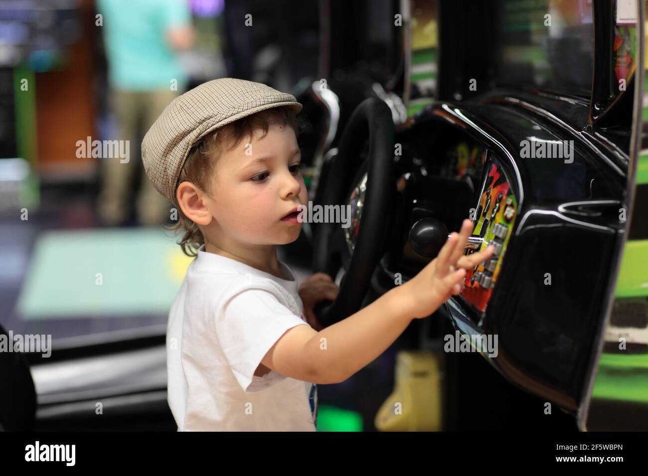 Child playing arcade game machine at an amusement park Stock Photo - Alamy