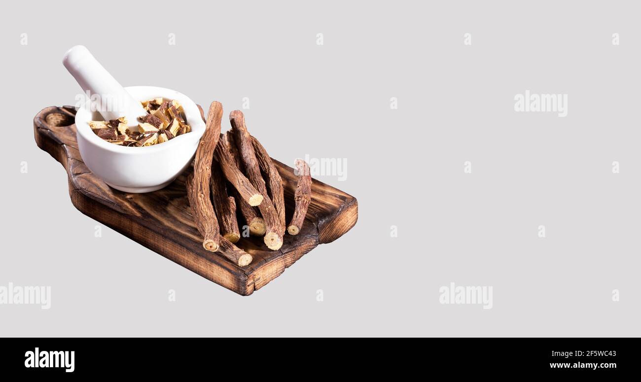 Licorice herb root used in chinese herbal medicine in a mortar with ...