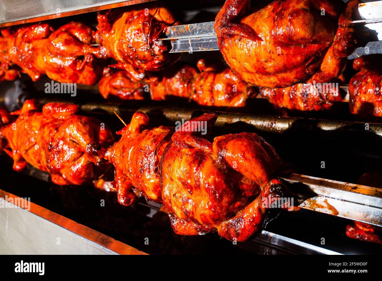 Barbecue roast Chicken in a row turning at industrial roaster Stock ...