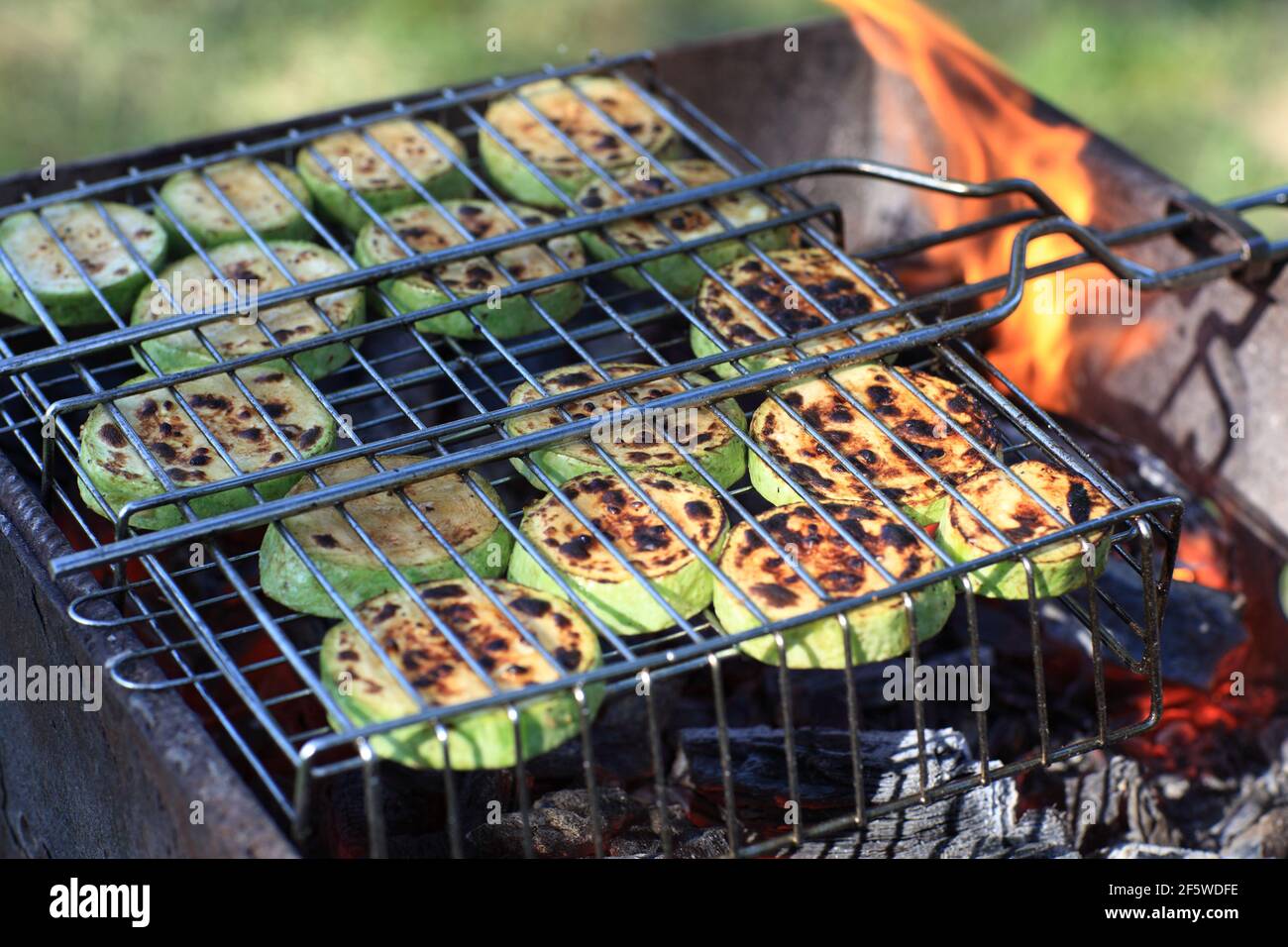 Cooking of vegetable marrow on barbecue grill at picnic Stock Photo - Alamy