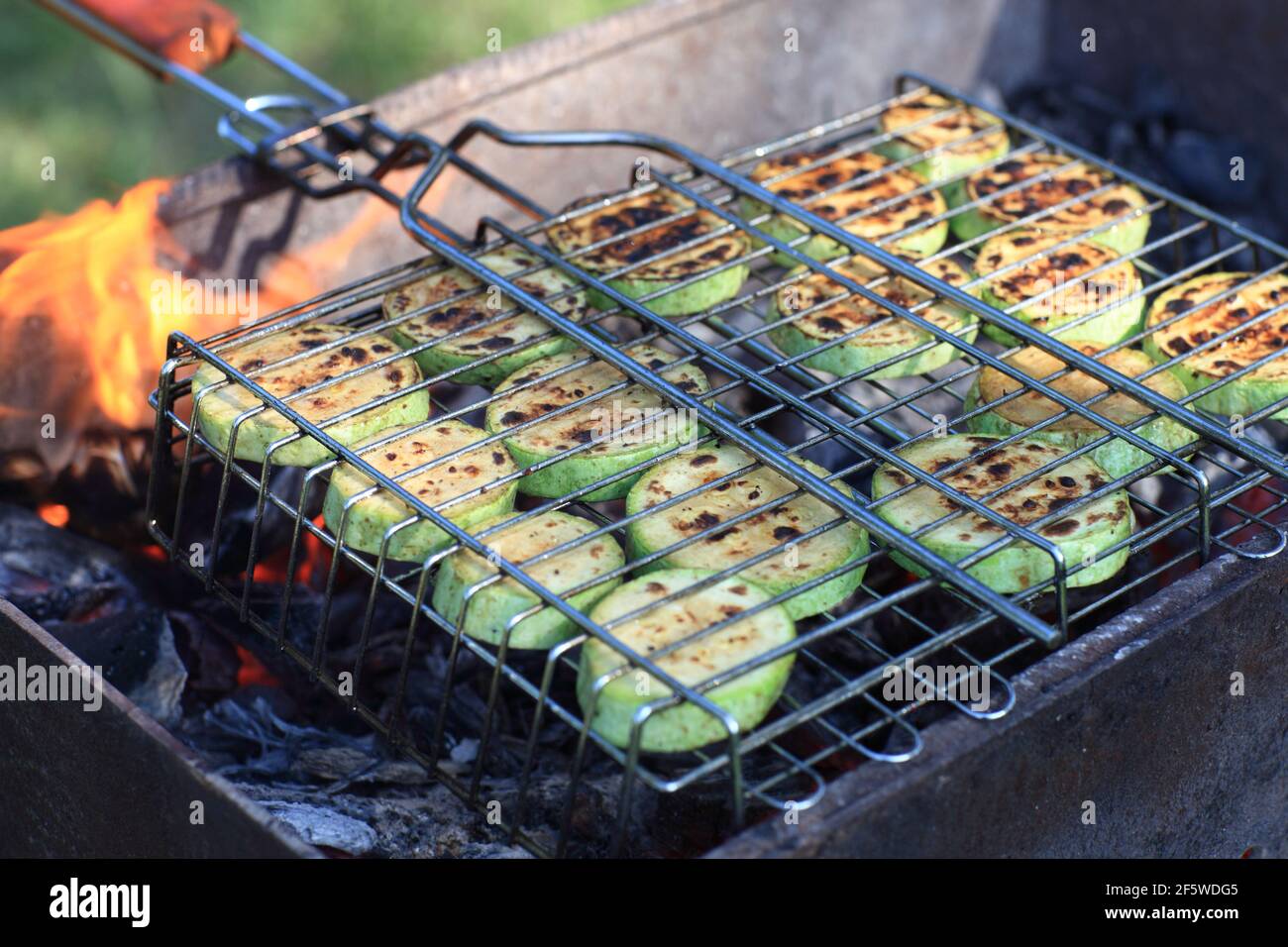Cooking of vegetable marrow on barbecue grill Stock Photo - Alamy