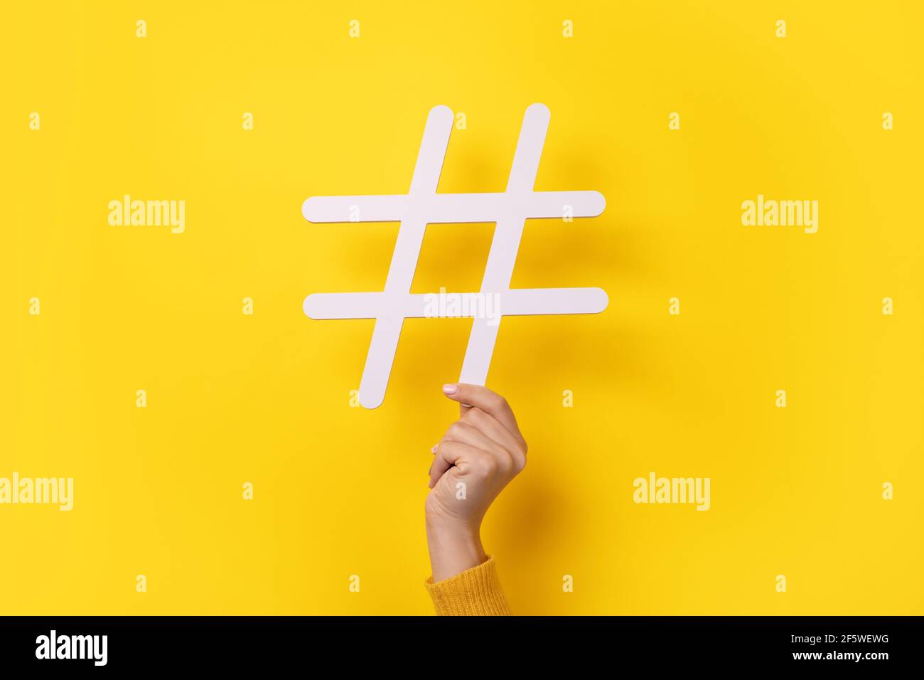 hand showing HASHTAG over yellow background, business concept Stock ...