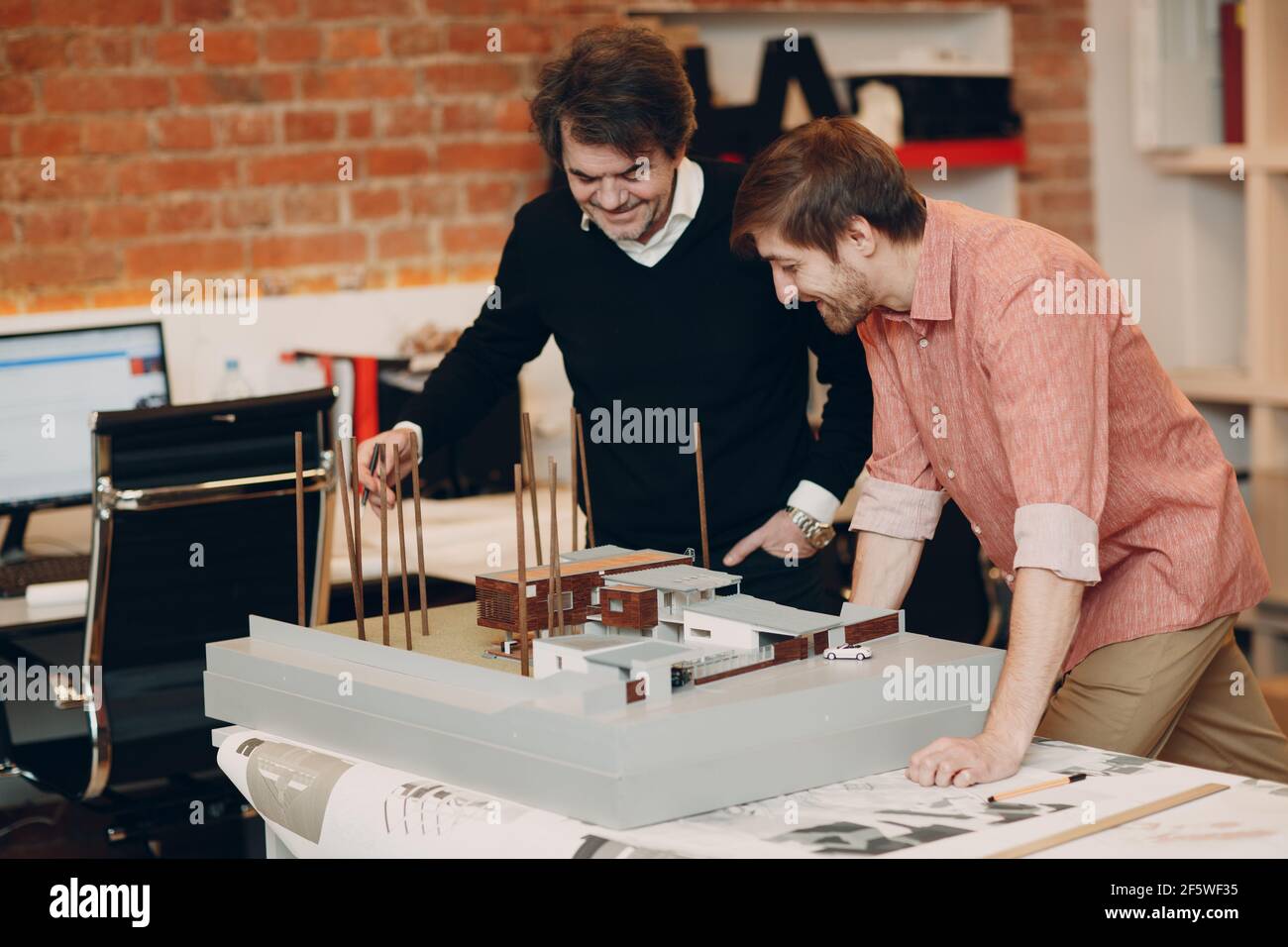 Architect with blueprints and layout design project at office bureau ...