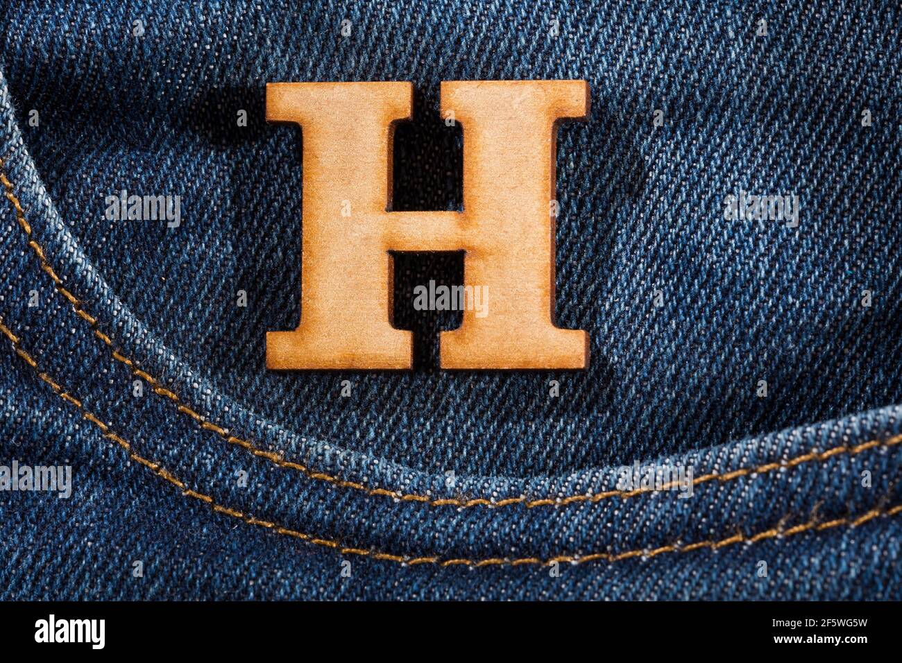Letter H of the alphabet - blue jeans texture background Stock Photo ...