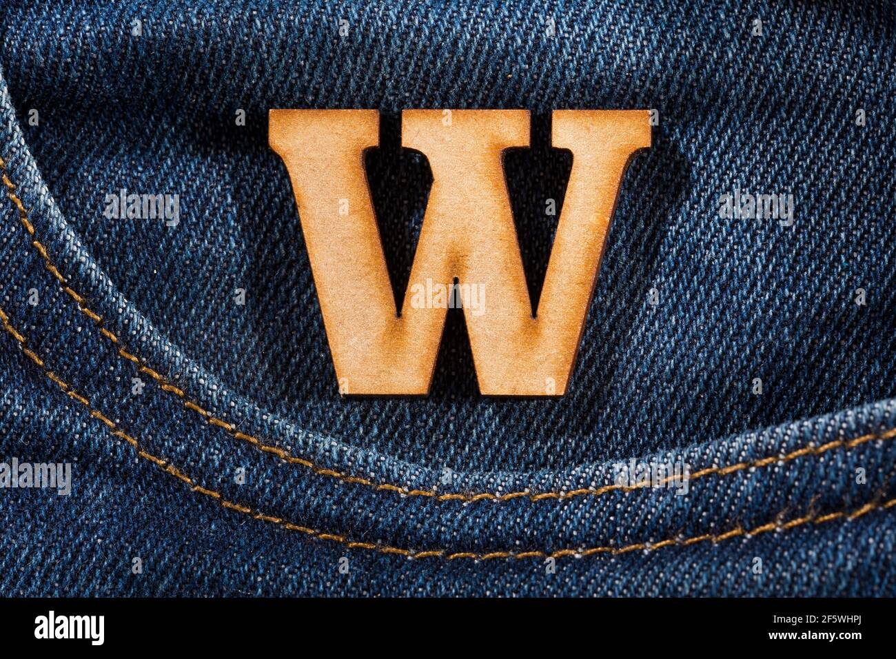 Letter W of the alphabet - blue jeans texture background Stock Photo ...