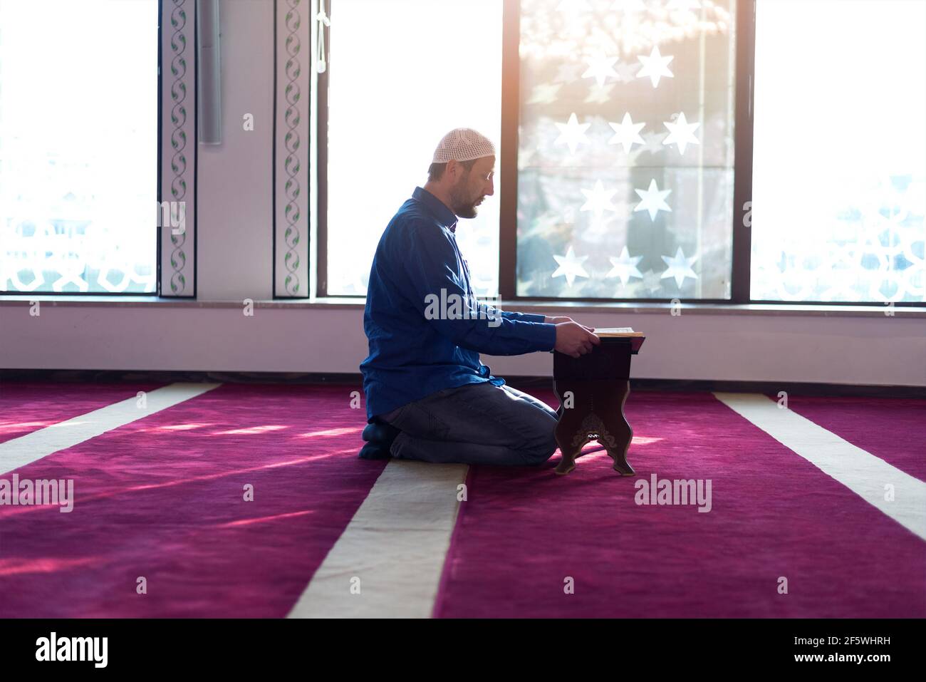 Muslim Man Reading Holy Book (Qur'an) Inside The Mosque Stock Photo - Alamy