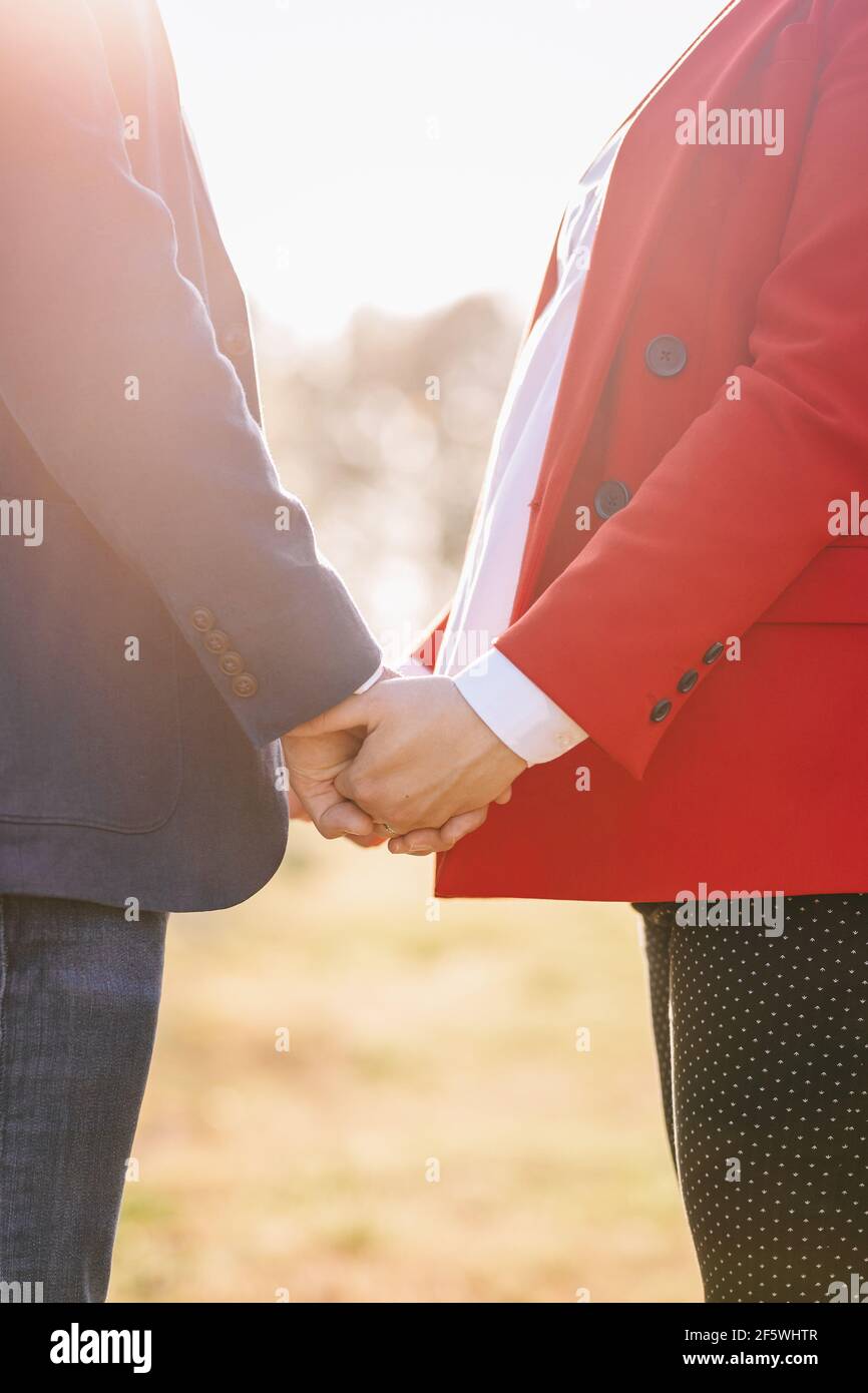 Couple standing holding others hand hi-res stock photography and images ...