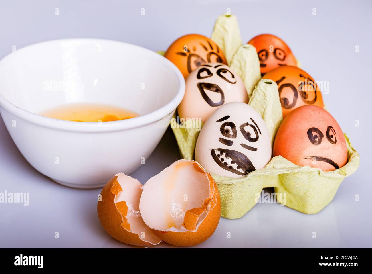 Crazy eggs terrified, Scared faces staring from egg tray at broken egg ...