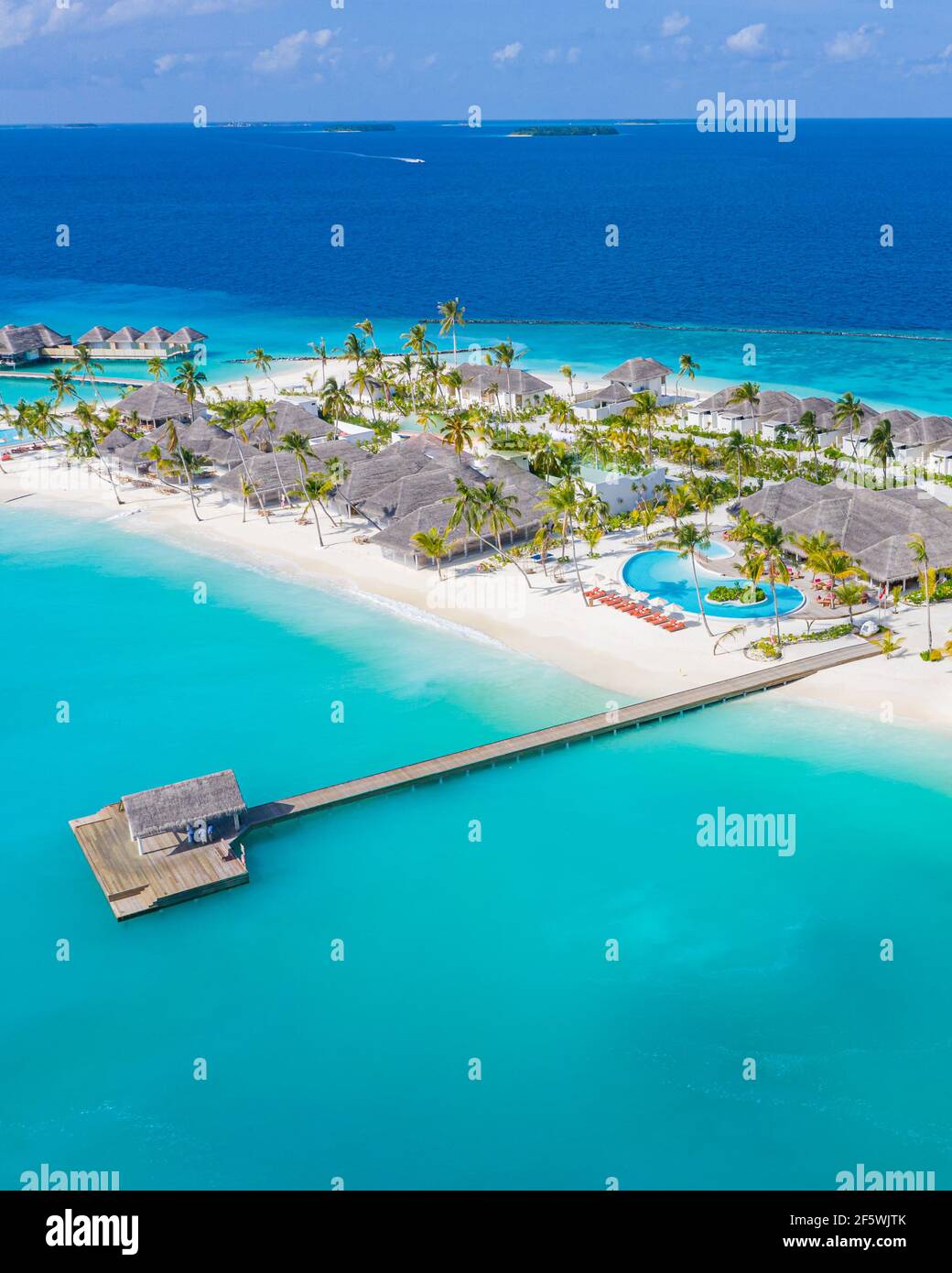 Aerial view of Maldives island, luxury water villas resort and wooden ...