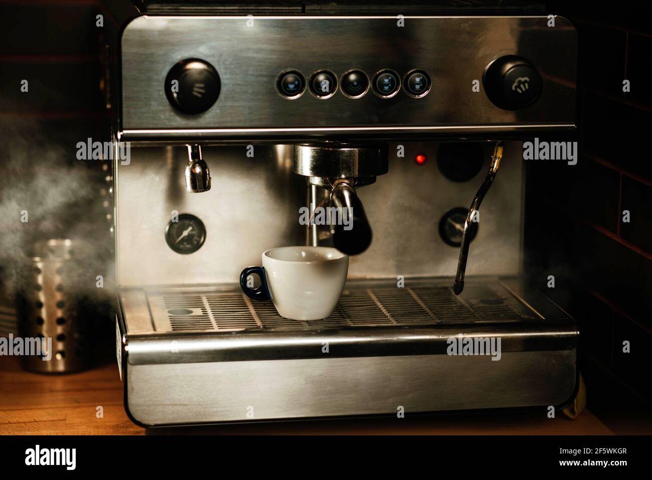 The coffee machine is dispensing steam Stock Photo - Alamy