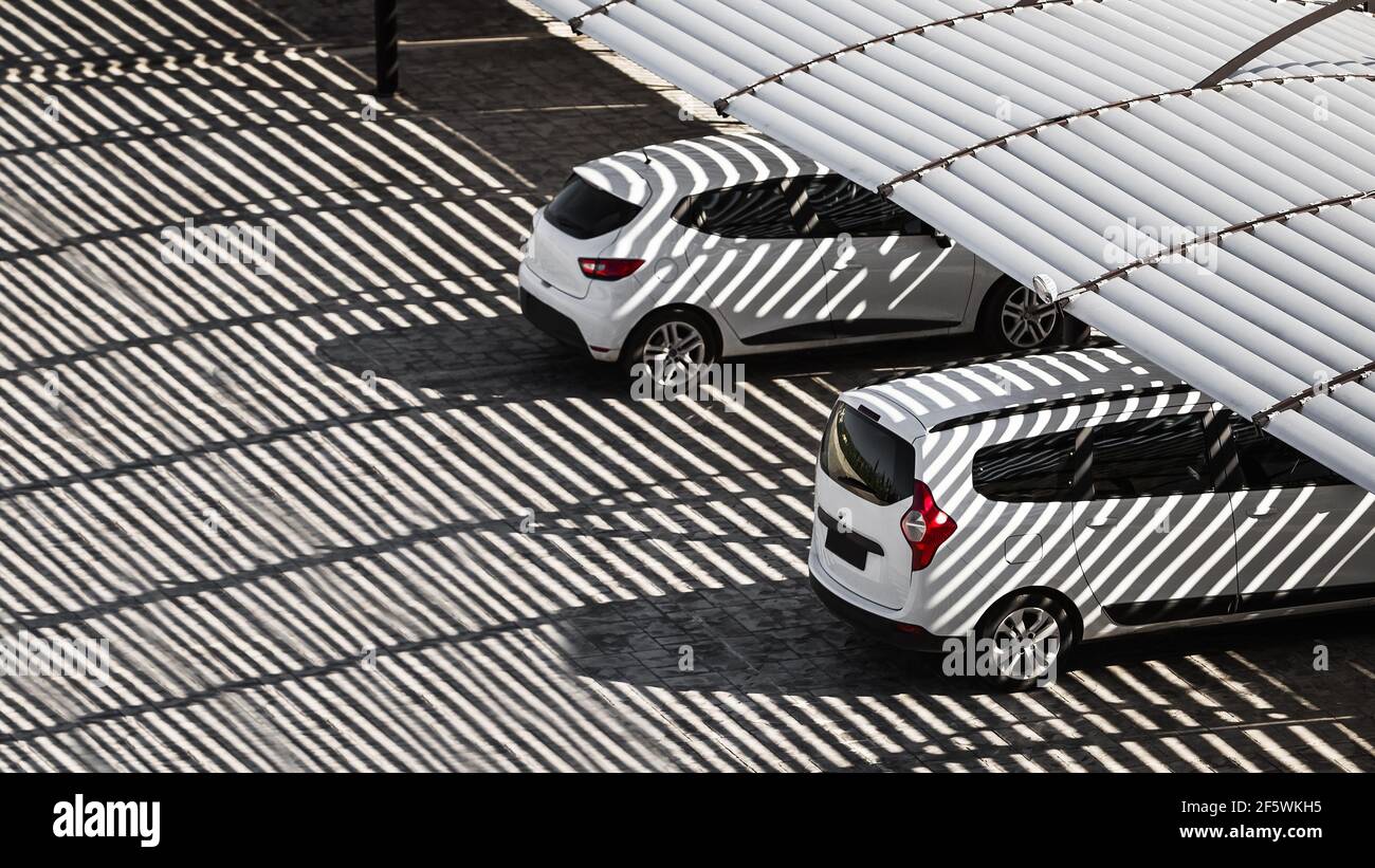 Cars under the shadow from the canopy Stock Photo - Alamy