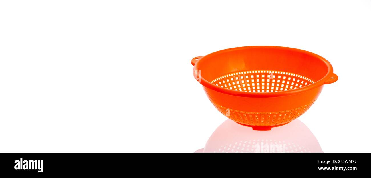 Red plastic kitchen strainer on white background Stock Photo - Alamy