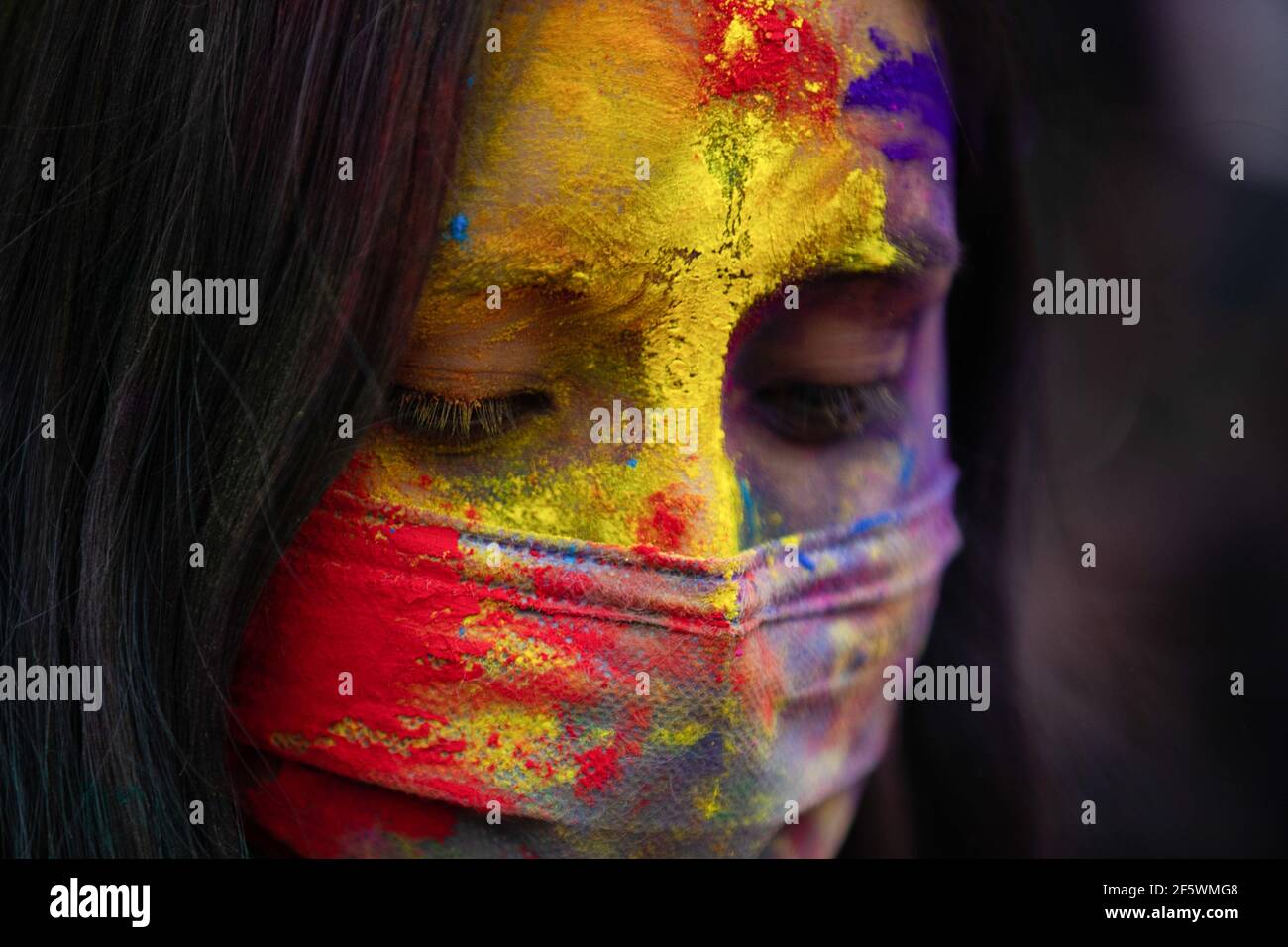 A woman's face covered with Vermilion powder seen during the festival ...
