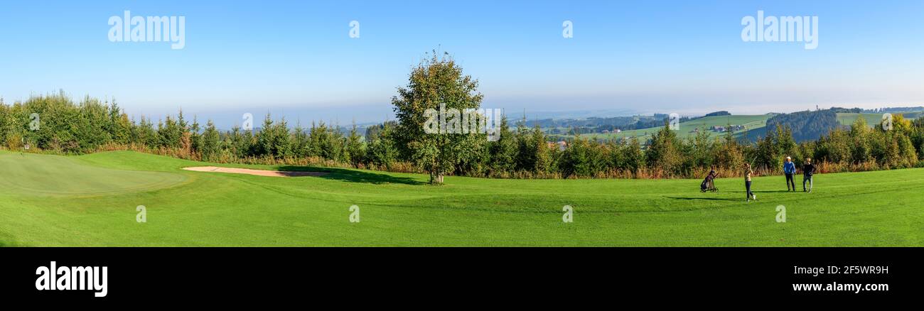 Golf as a family sport - family flight playing a parkland course Stock ...
