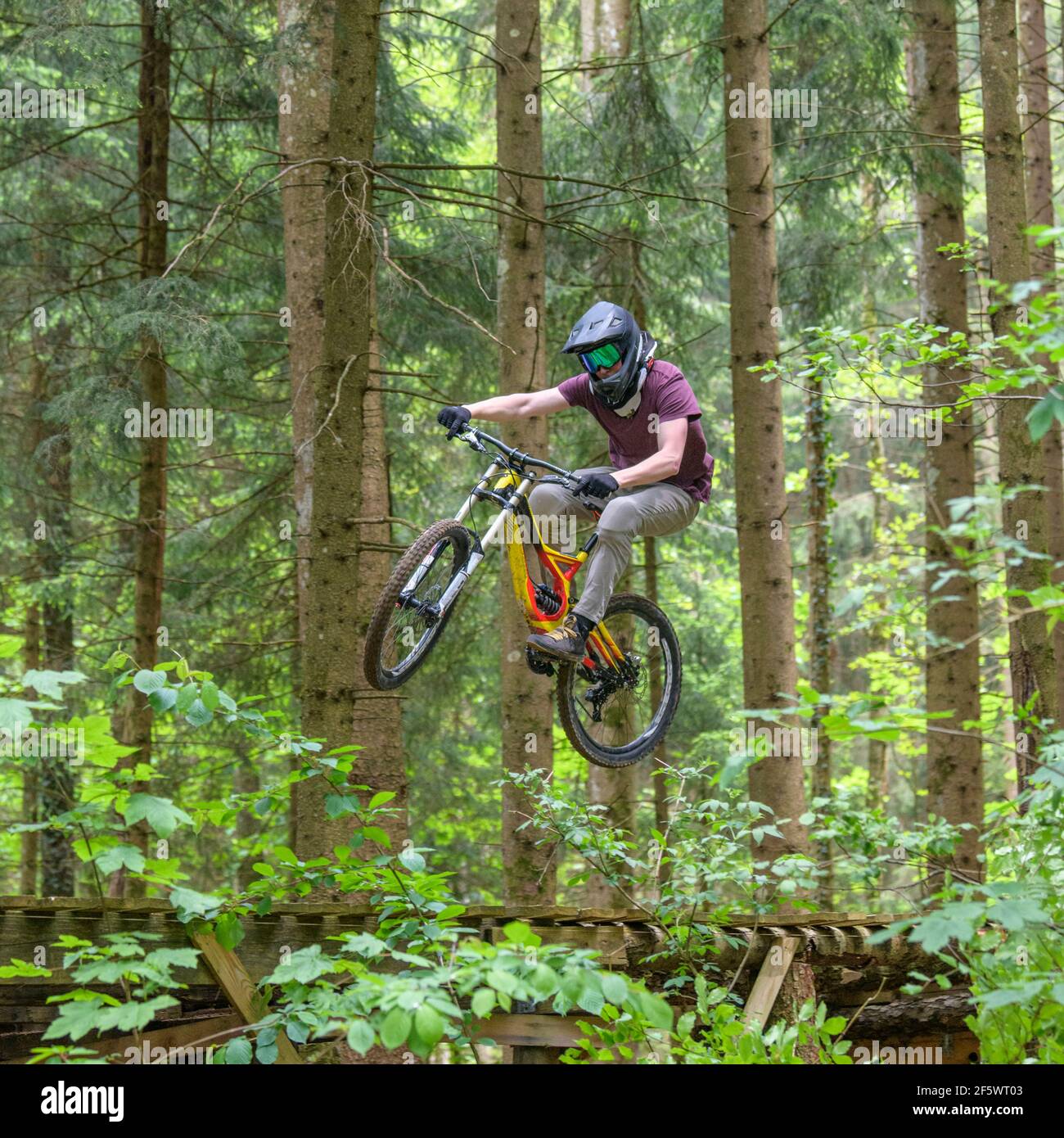 Jump session of professional young mountainbikers in a bike park in ...