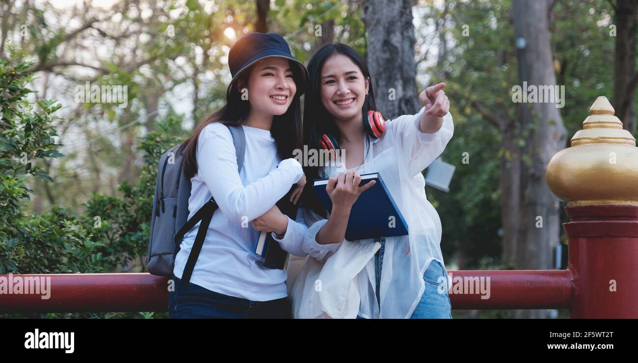 Two Young students from university enjoying excursion in park and ...