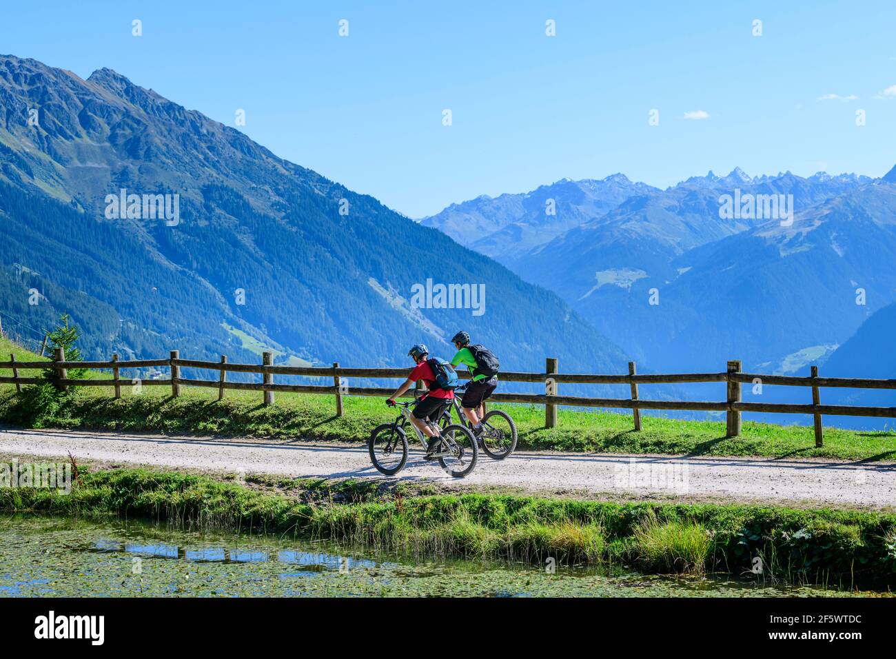 Two friends cycling in beautiful alpine nature Stock Photo - Alamy