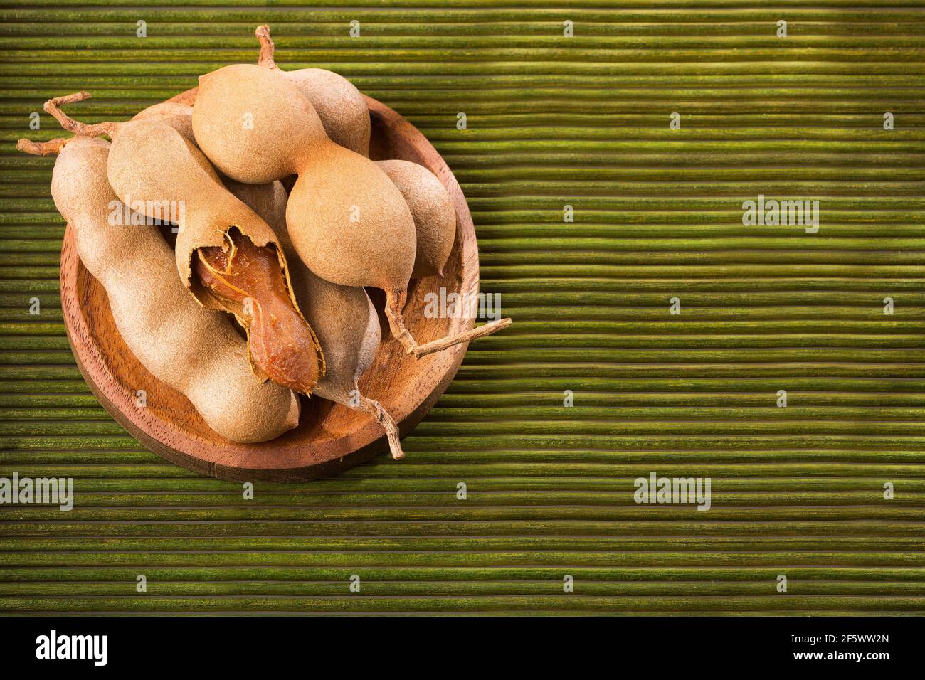 Tamarind tropical fruit - Tamarindus indica. Wood background Stock ...