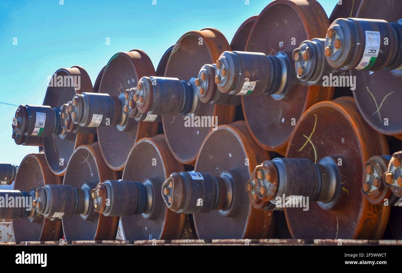 New train wheels being hauled on a train with metal chains in El Paso ...