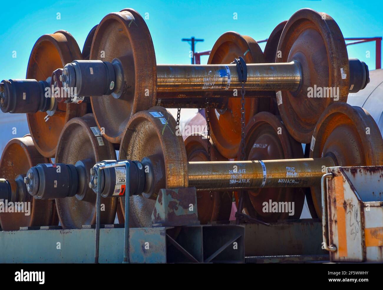 New train wheels being hauled on a train with metal chains in El Paso ...