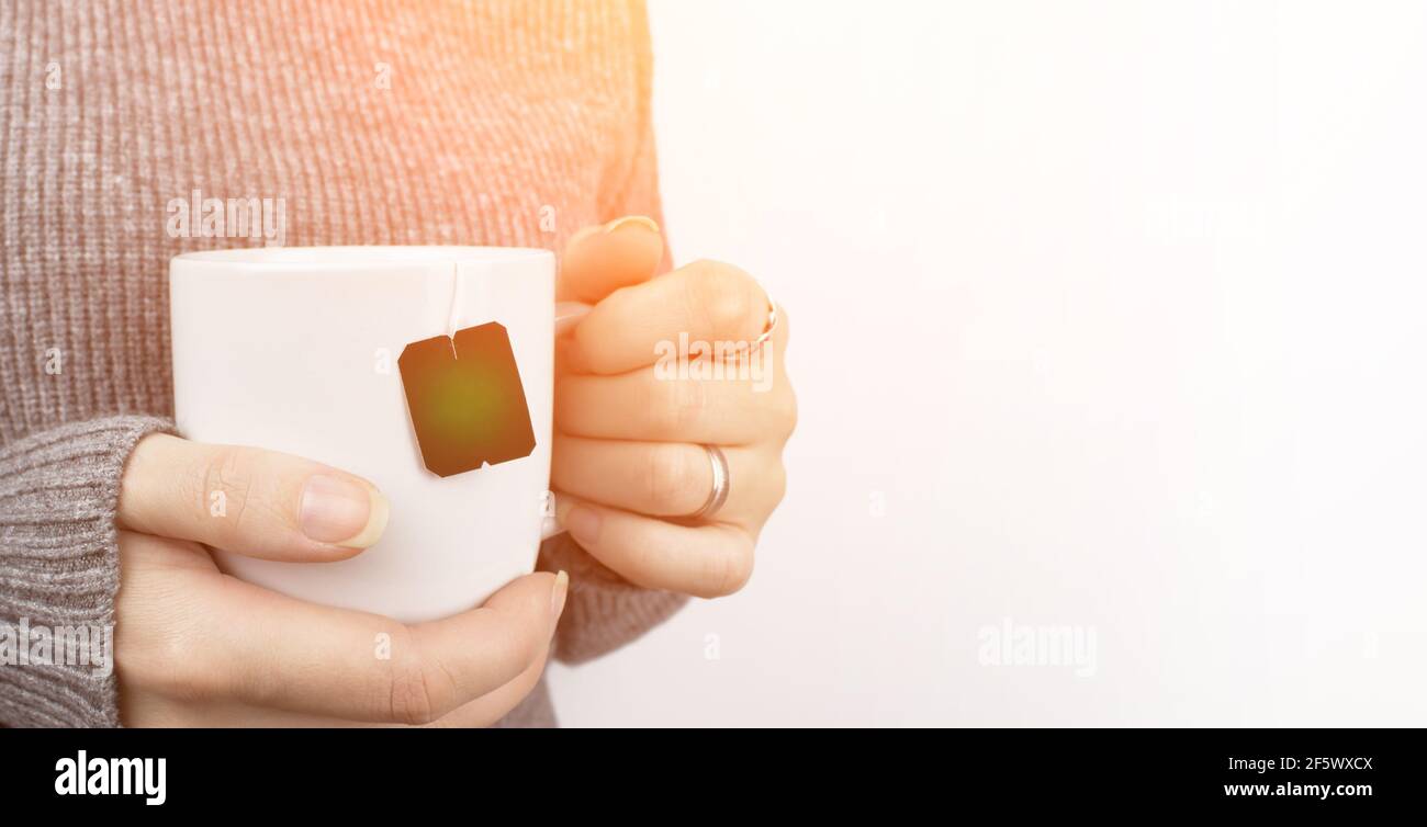 Girl hold white cup of morning tea in hand on white background with ...