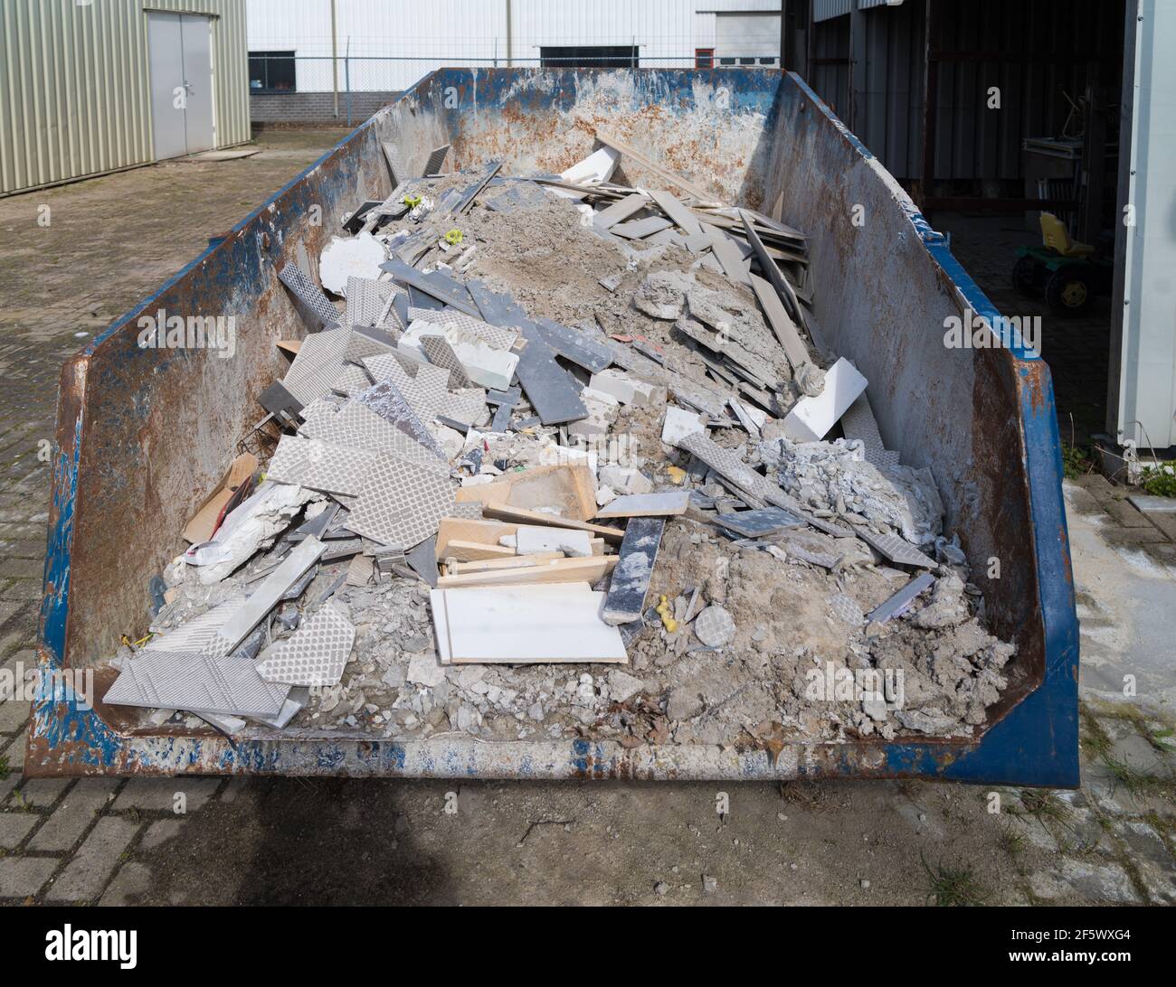 container with construction waste Stock Photo - Alamy