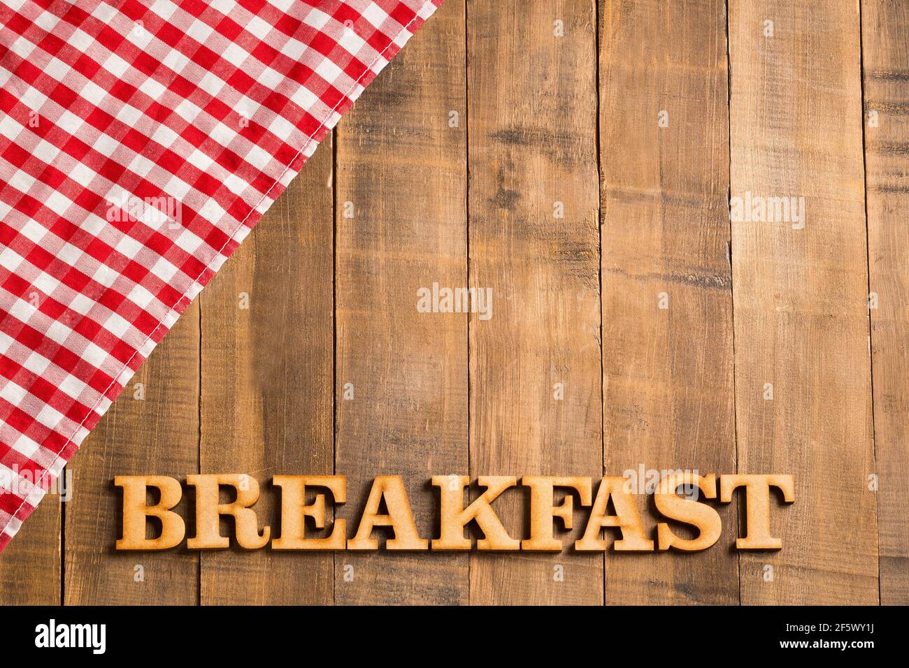 Picnic breakfast - Checkered red napkin and wooden letters. Background ...