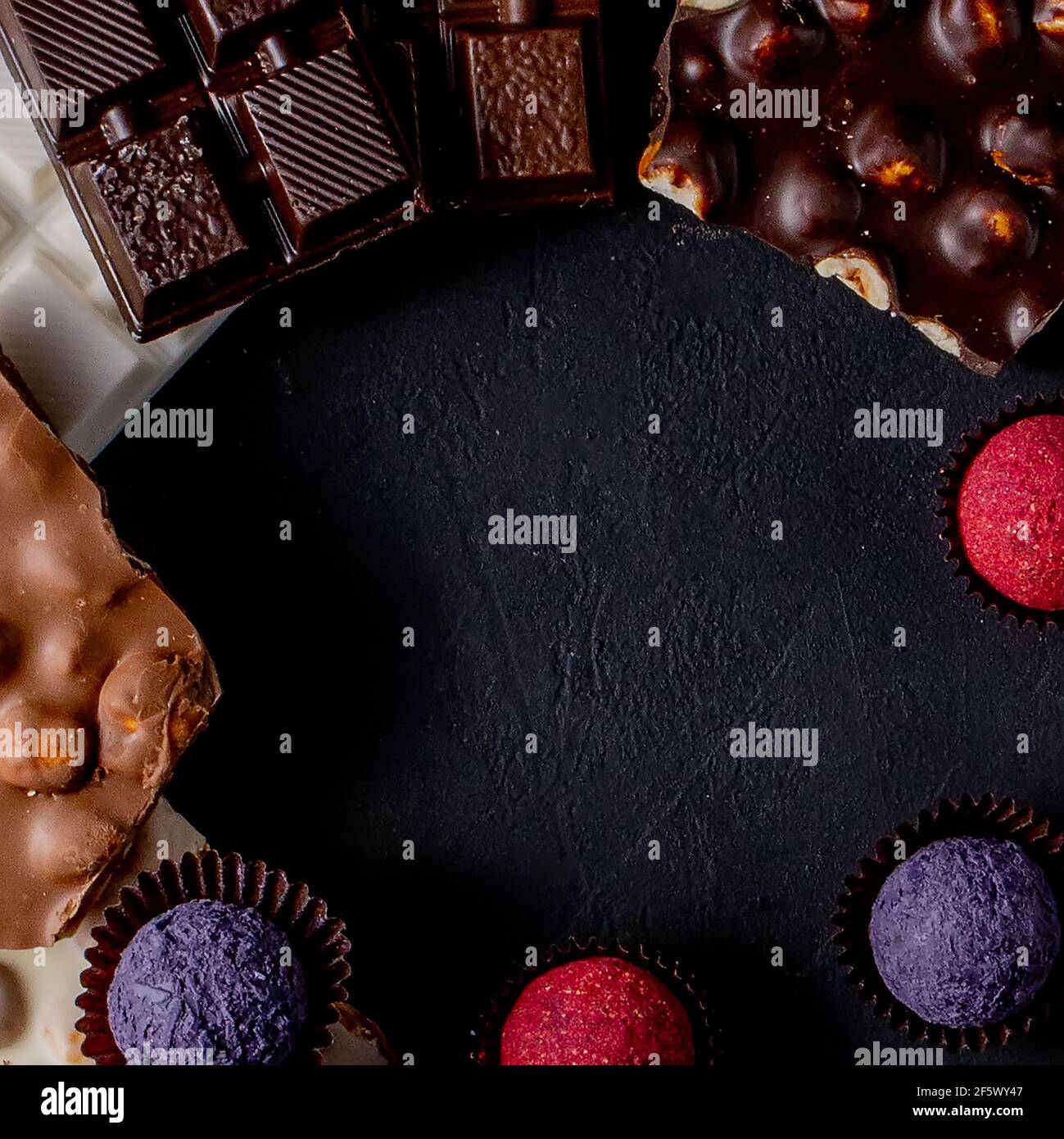 Chocolate bar, crushed pieces of dark chocolate and nuts. Praline ...